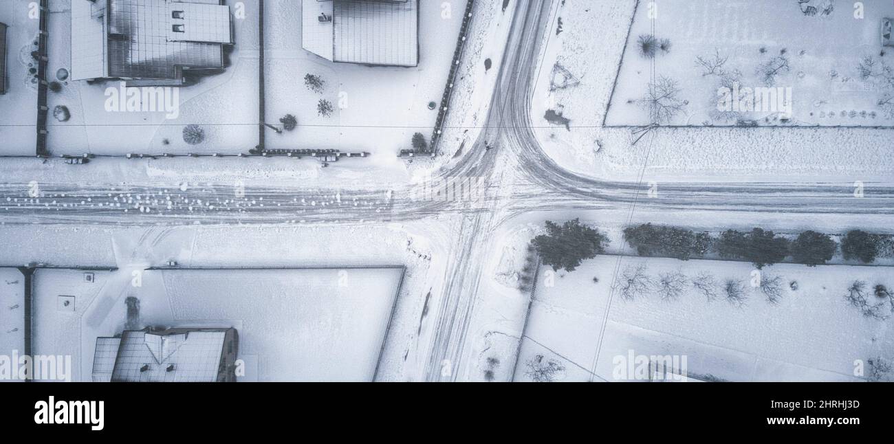 Top view of a snow-covered field with roads and buildings Stock Photo ...