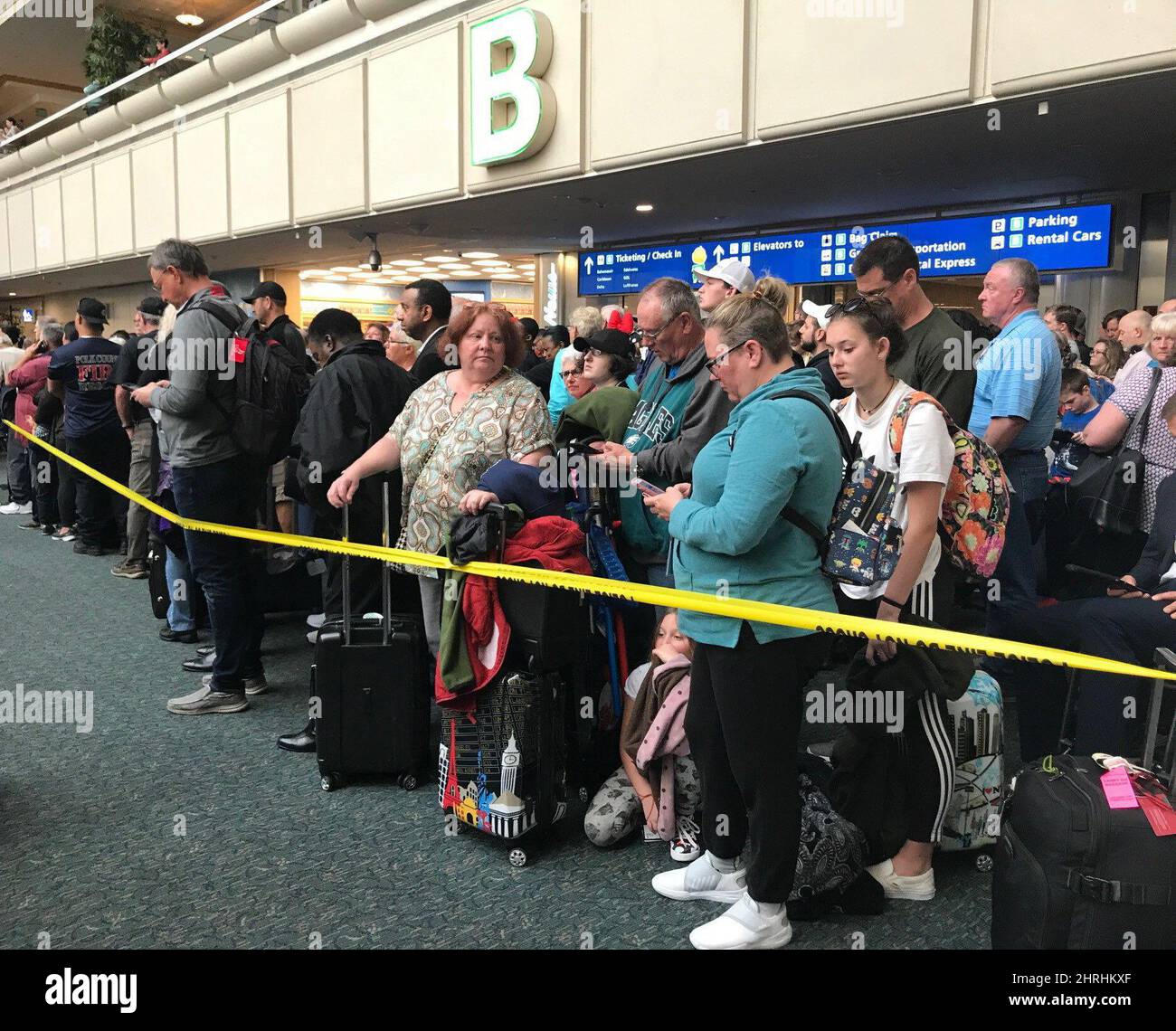People wait to get through security at the Orlando International ...