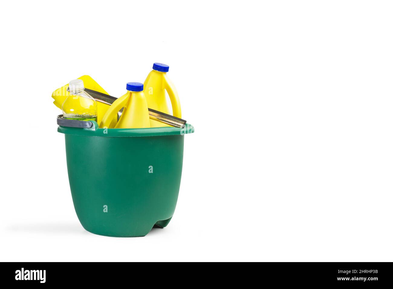 A green cleaning bucket and bleach bottles on a white background with ...