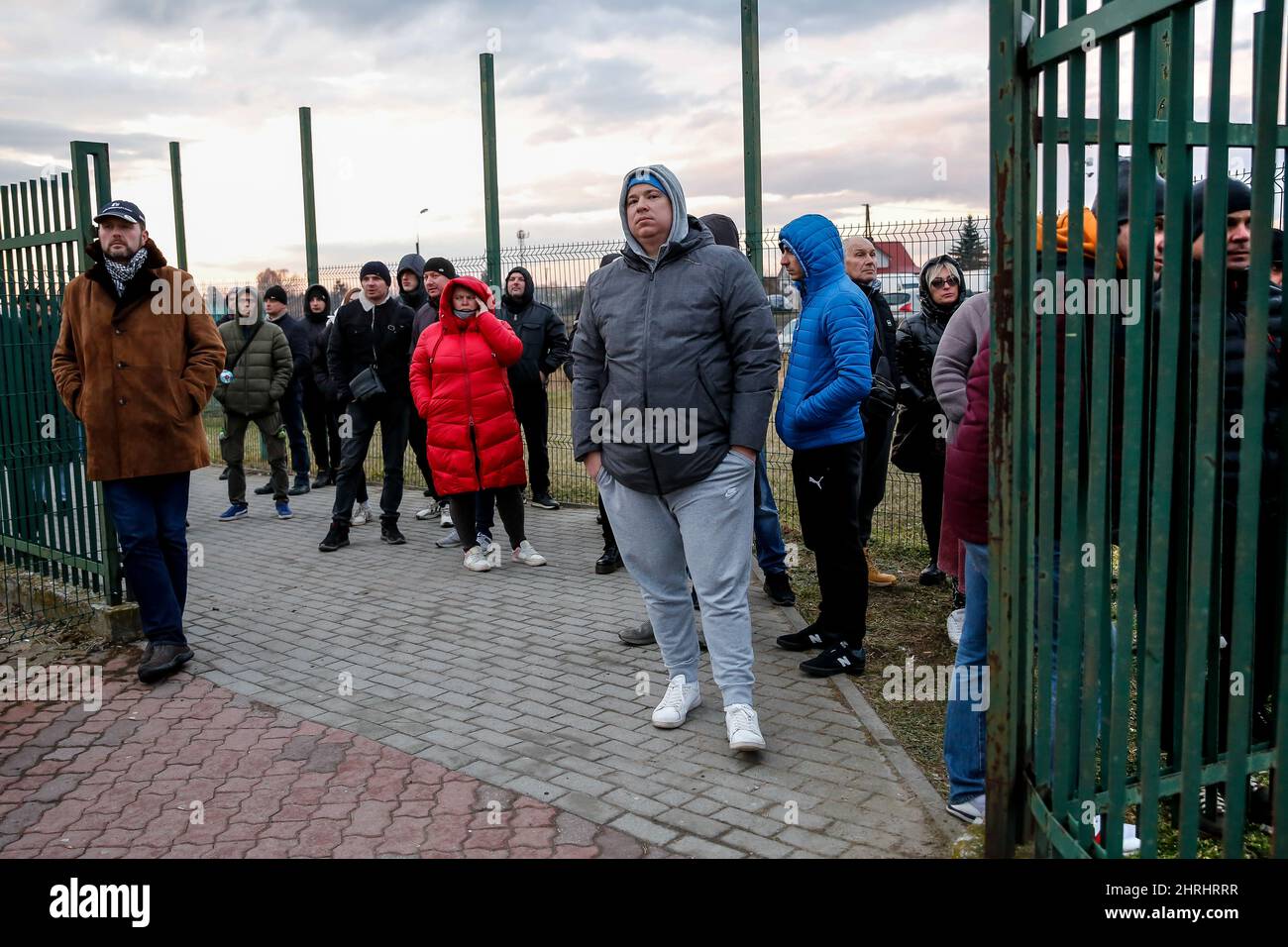 Ukrainians wait by the border passage for an arrival of their loved ...
