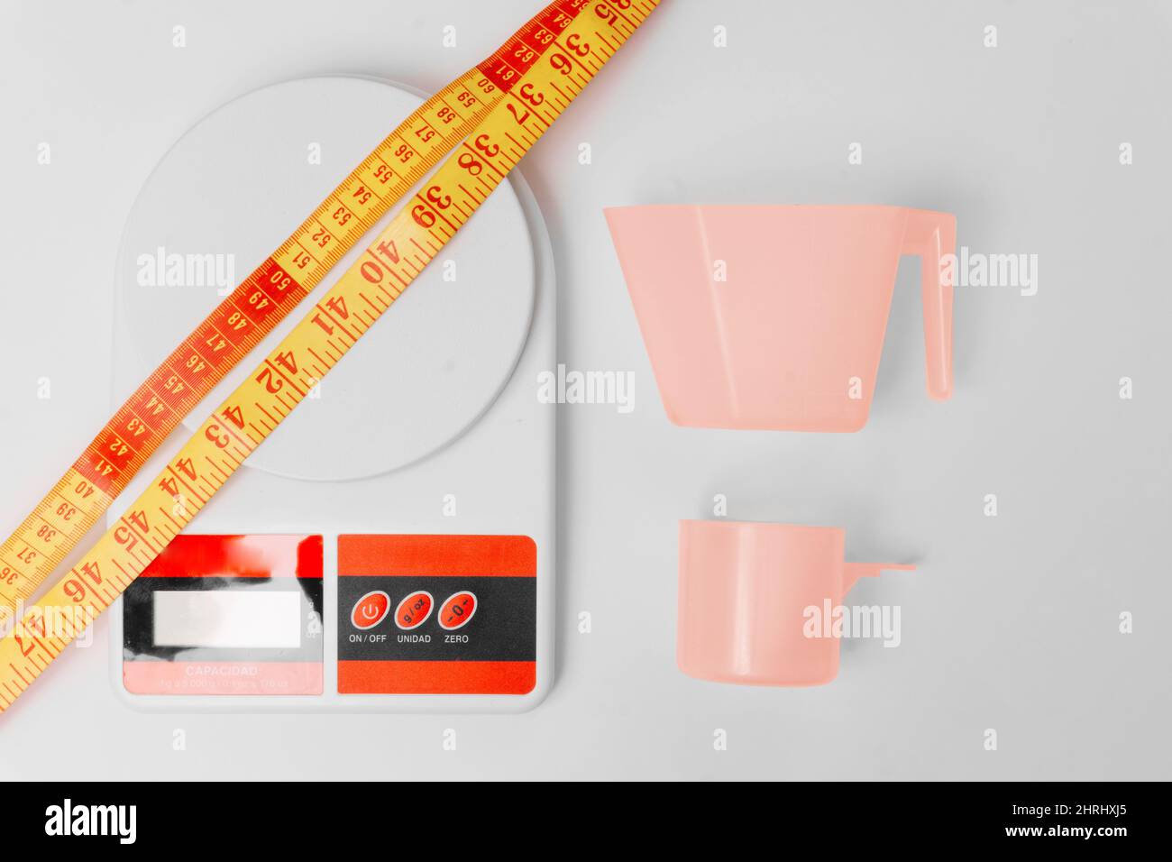 Zenith shot of kitchen scale, a meter, and scoops over white background ...