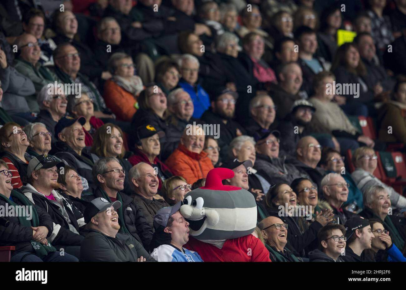 Curling Canada mascot "Slider" kisses a curling fan during the final ...