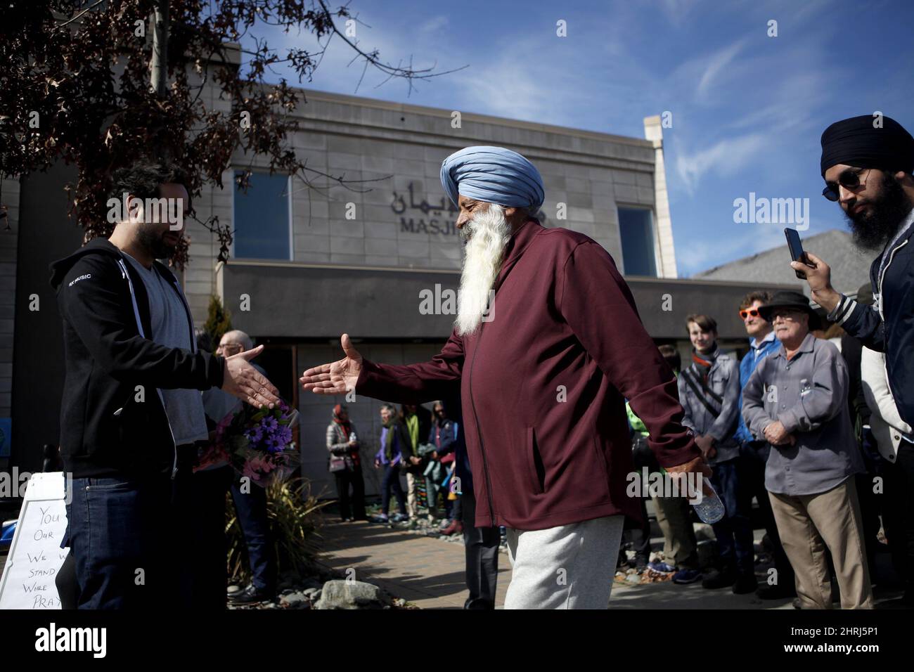 Baljinder Singh, right, shakes hands with a friend as people gather ...