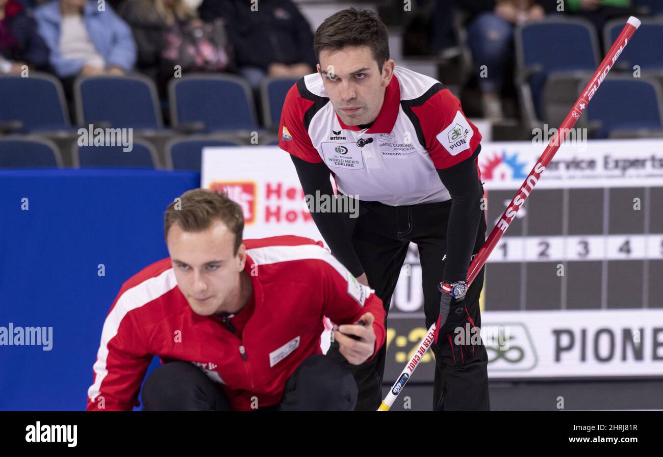 Switzerland skip Peter de Cruz looks over the shoulders of Norway skip ...