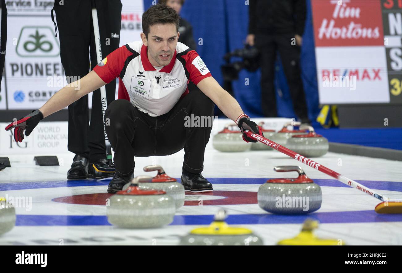 Switzerland skip Peter de Cruz directs a shot in their game against ...