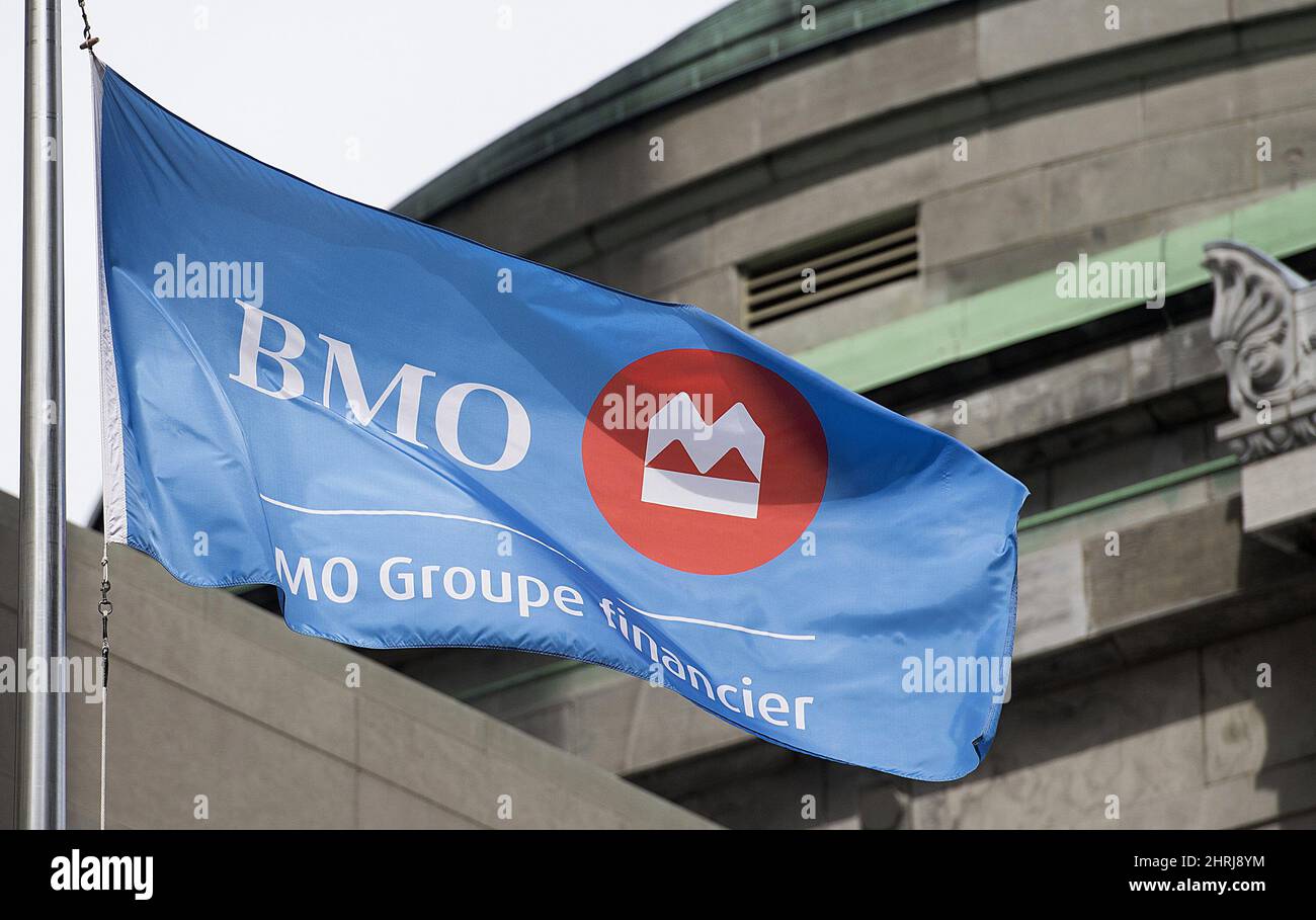 A BMO flag flaps in the wind outside the Bank of Montreal head office ...