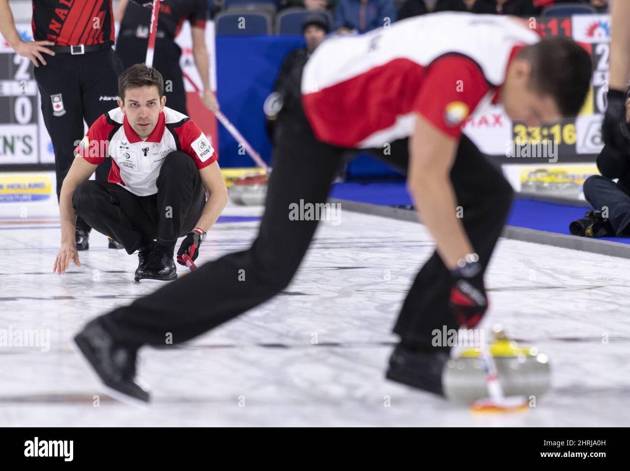 Switzerland skip Peter de Cruz watches his shot being swept by lead ...
