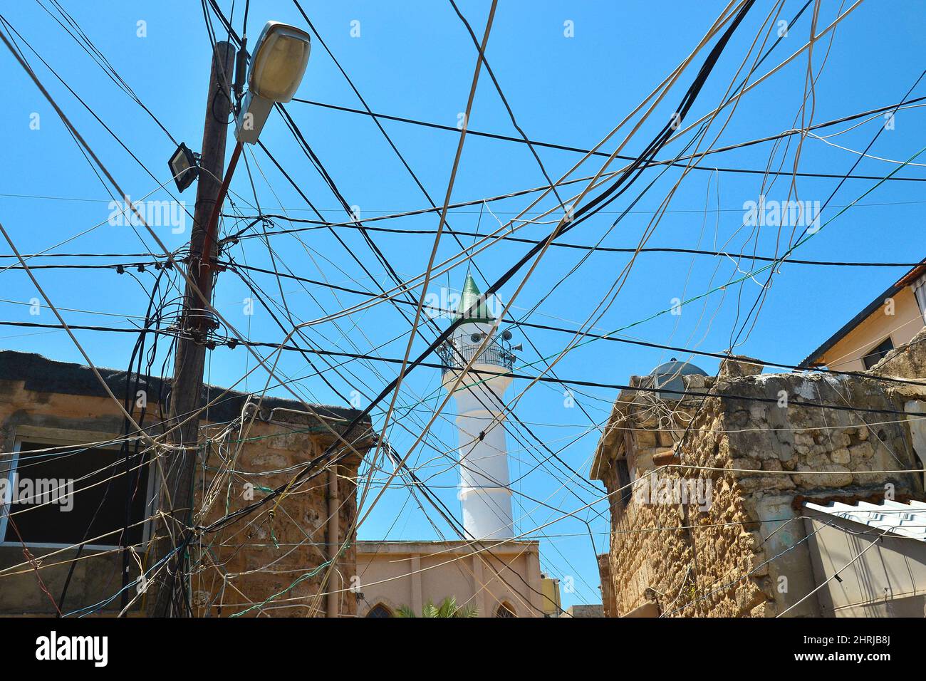 Power lines, a messy mess of power lines between houses in the ancient ...