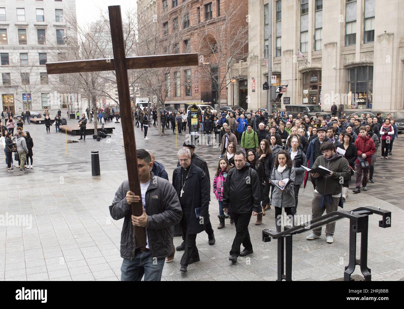 The faithful walk along a street during the Stations of the Cross in ...