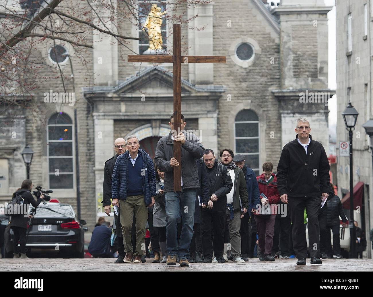 The faithful walk along a street during the Stations of the Cross in ...