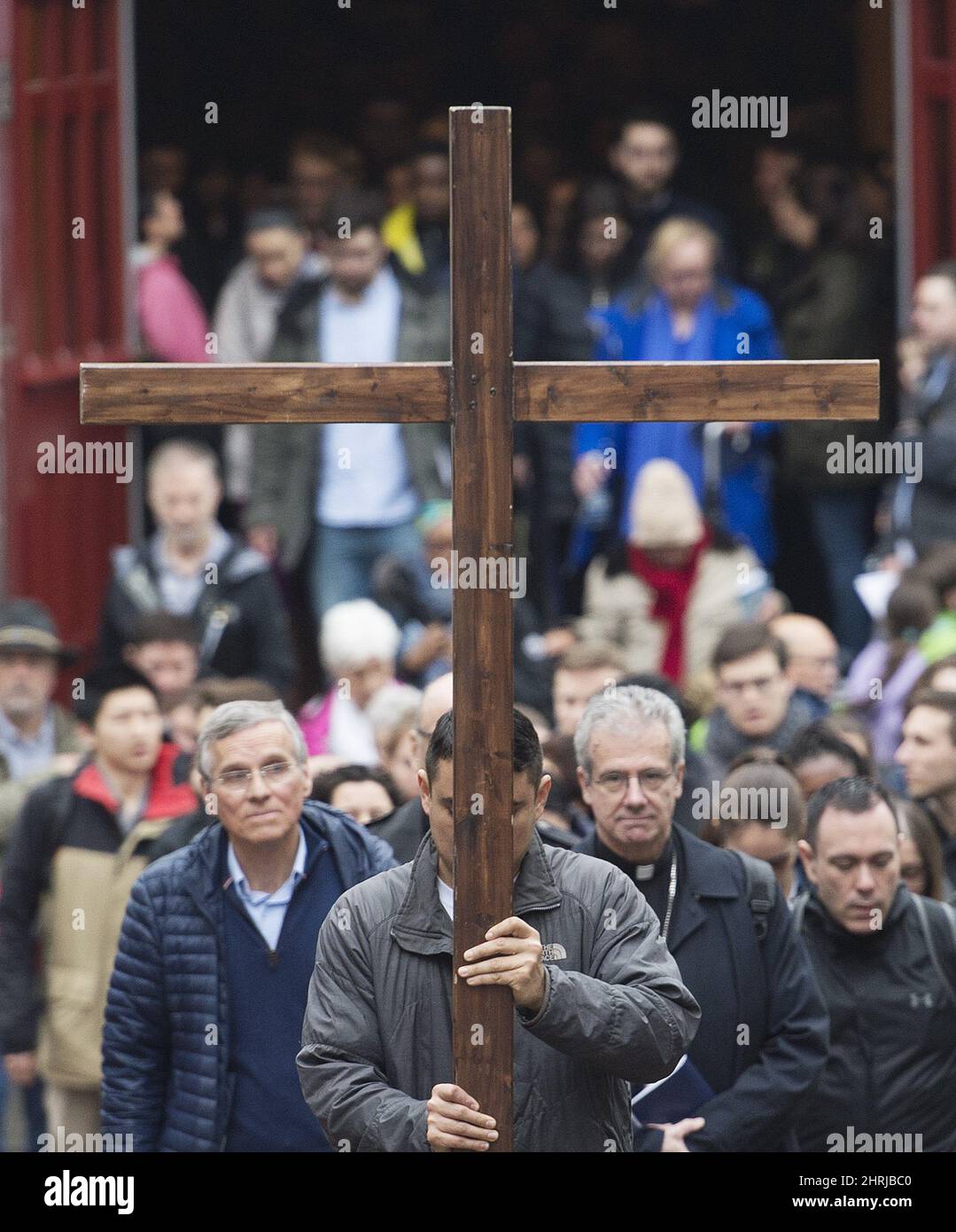 The faithful walk along a street during the Stations of the Cross in ...