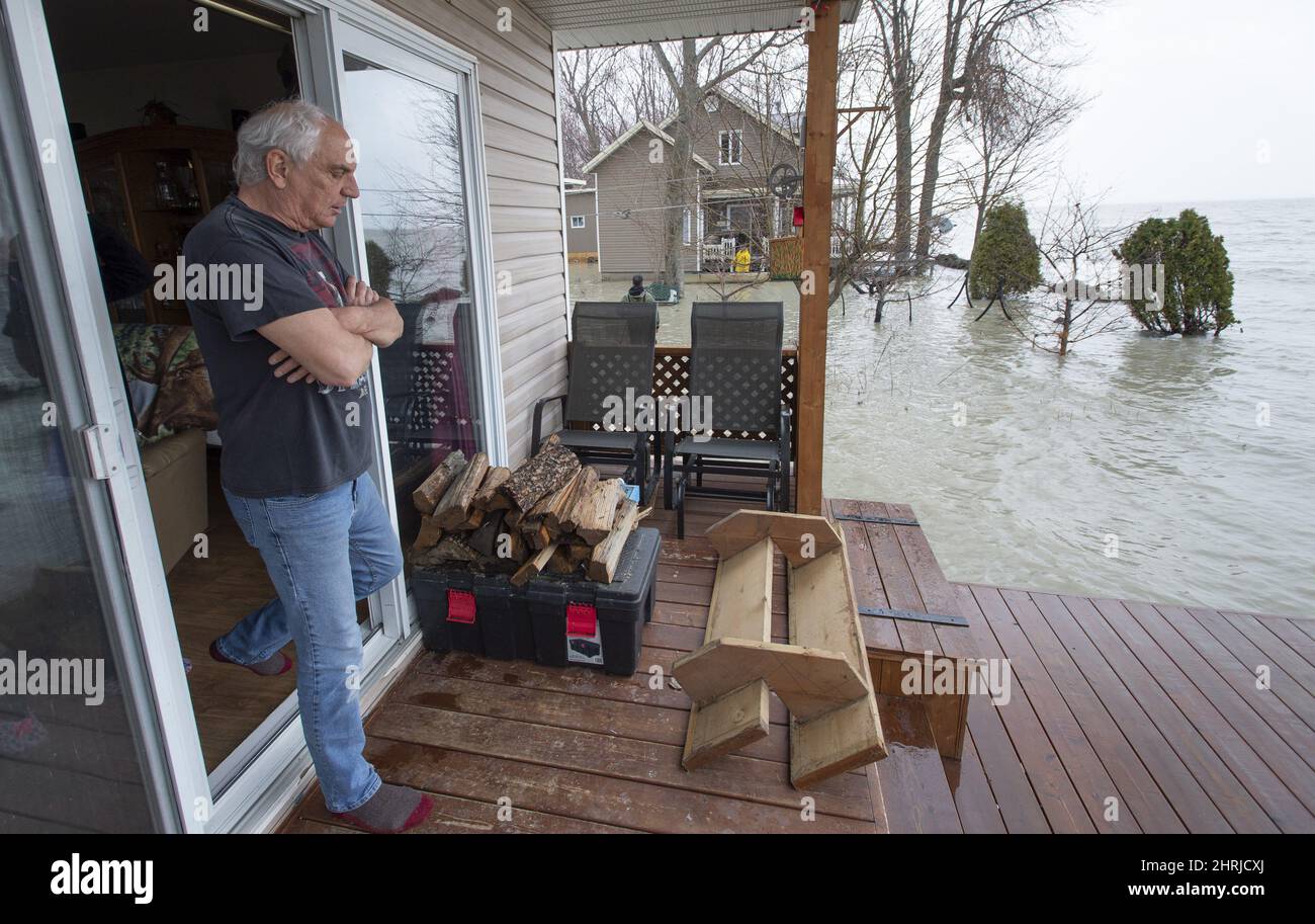 Christian Montigny walks onto the front porch of his flooded house in a ...