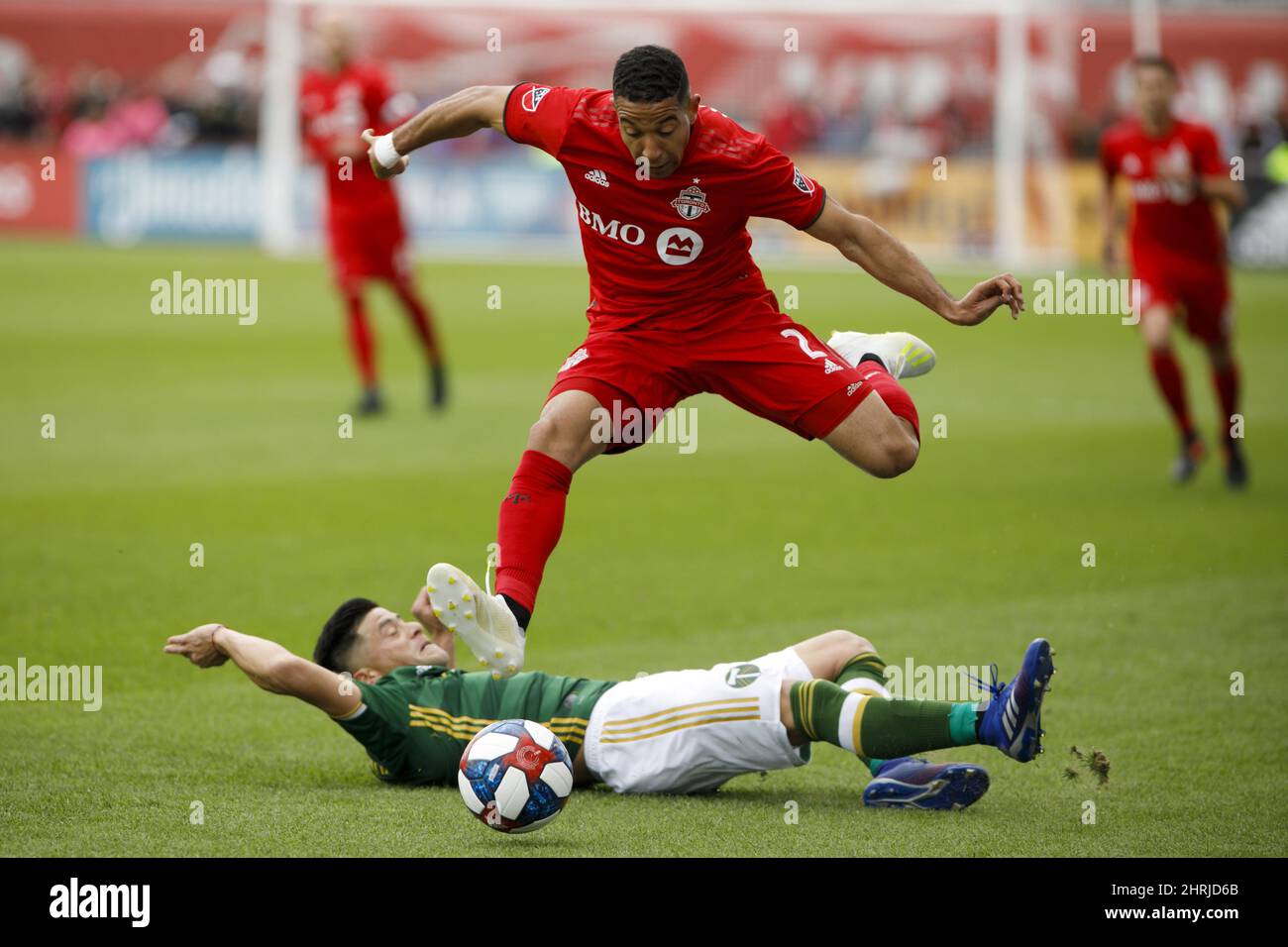 Toronto FC defender Justin Morrow (2) leaps over Portland Timbers ...