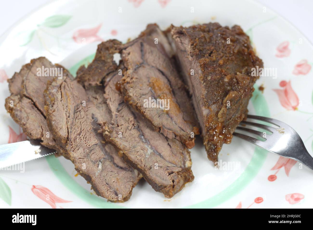 The pork meat cheek dish made with red wine Stock Photo - Alamy