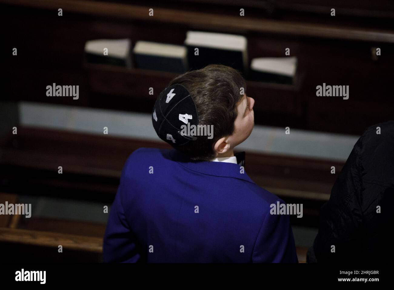 A mourner wears a yarmulke with the #4 on it, during the funeral mass ...