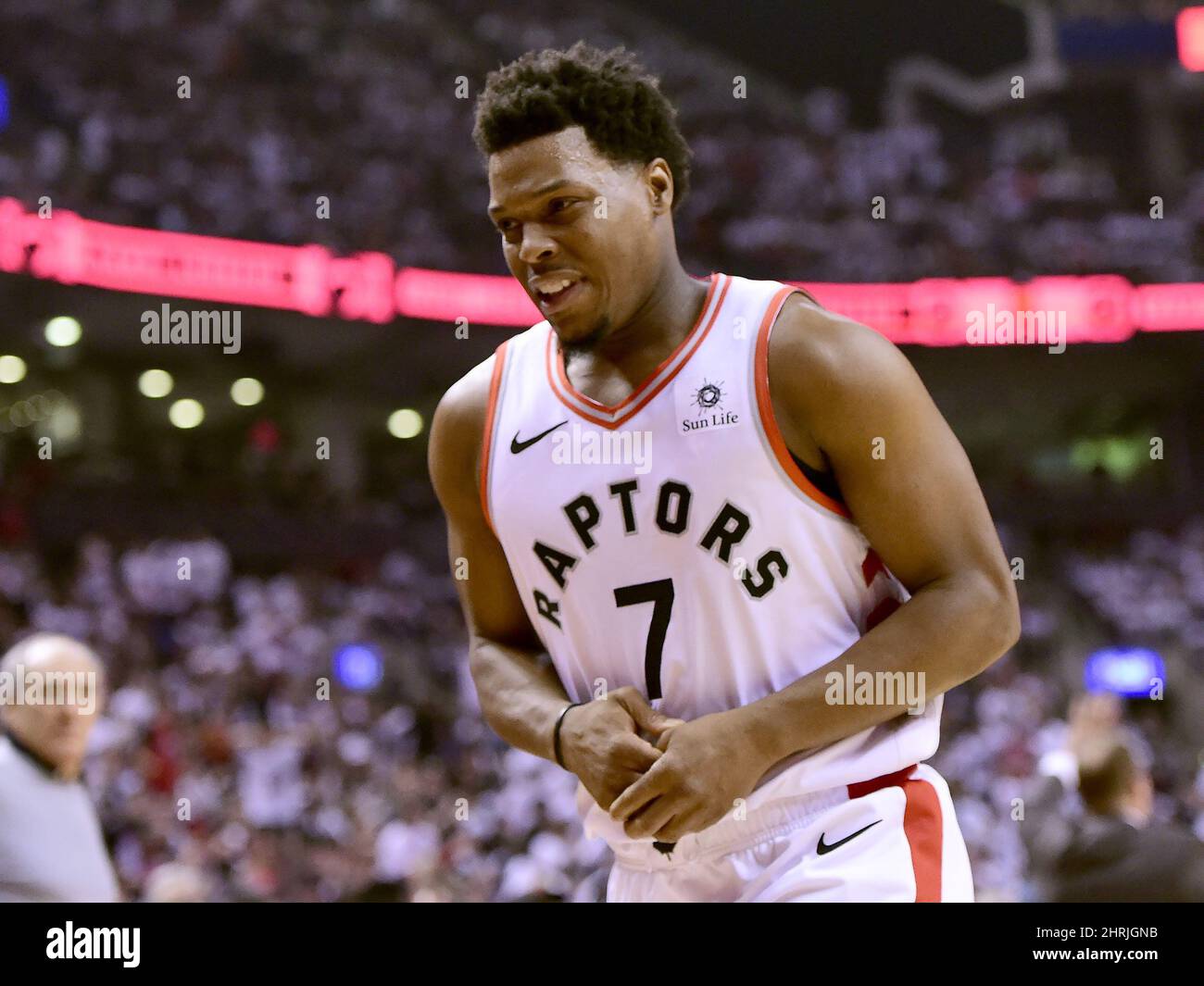 Toronto Raptors guard Kyle Lowry (7) walks off the court nursing his ...