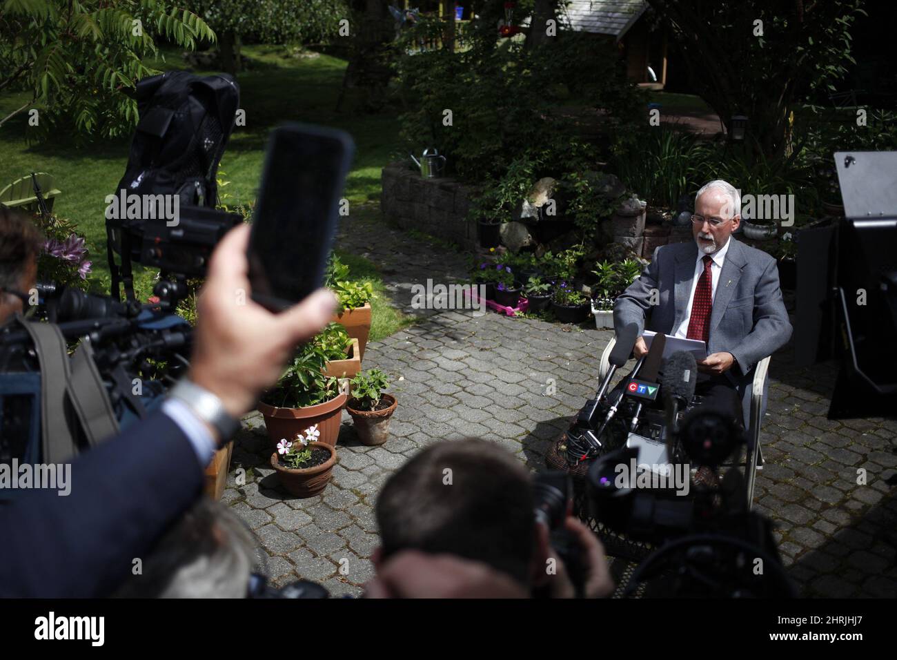 Suspended Sgt-at-arms Gary Lenz gives an interview from his backyard ...