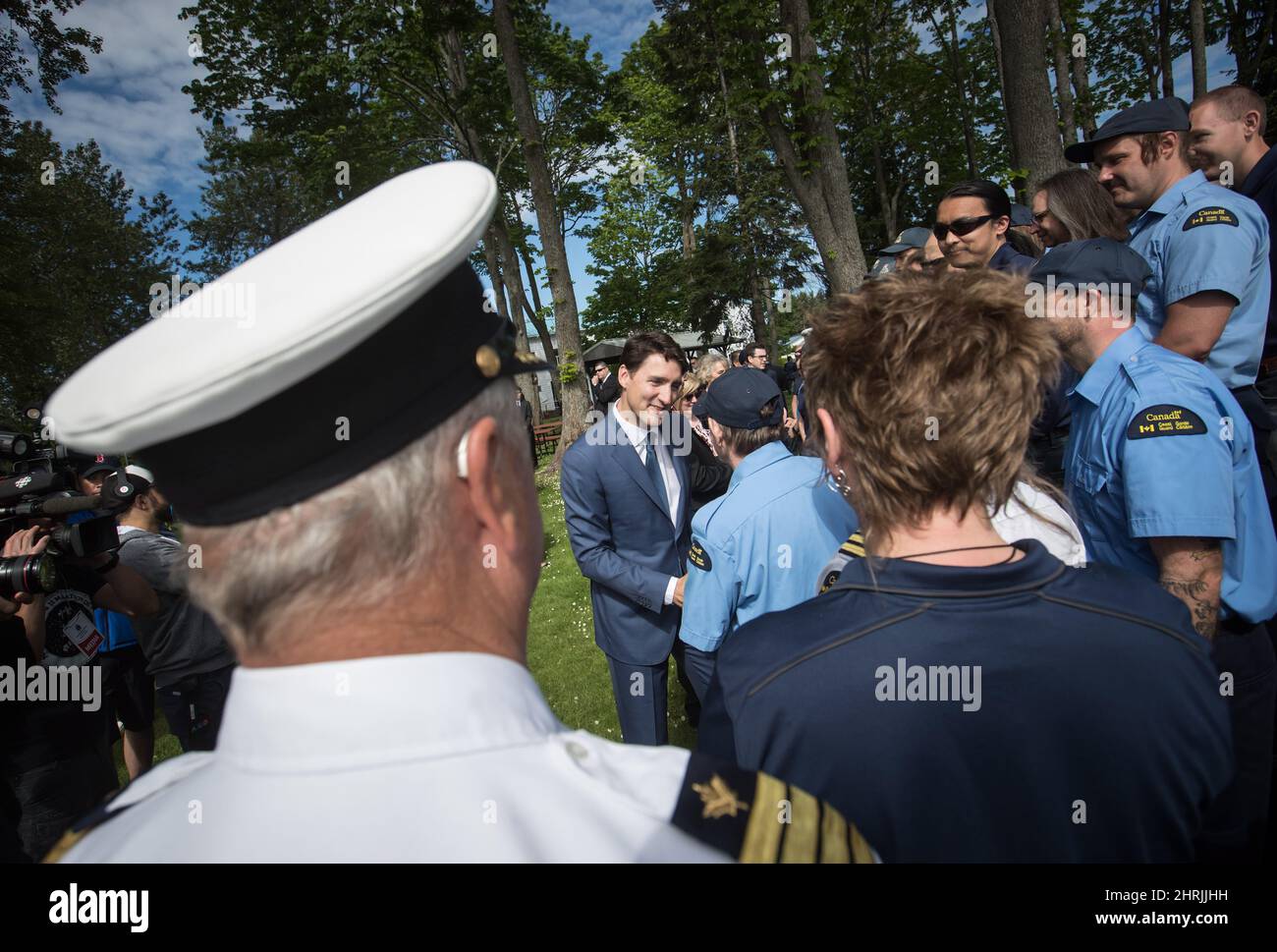 Prime Minister Justin Trudeau, back centre, greets members of the ...
