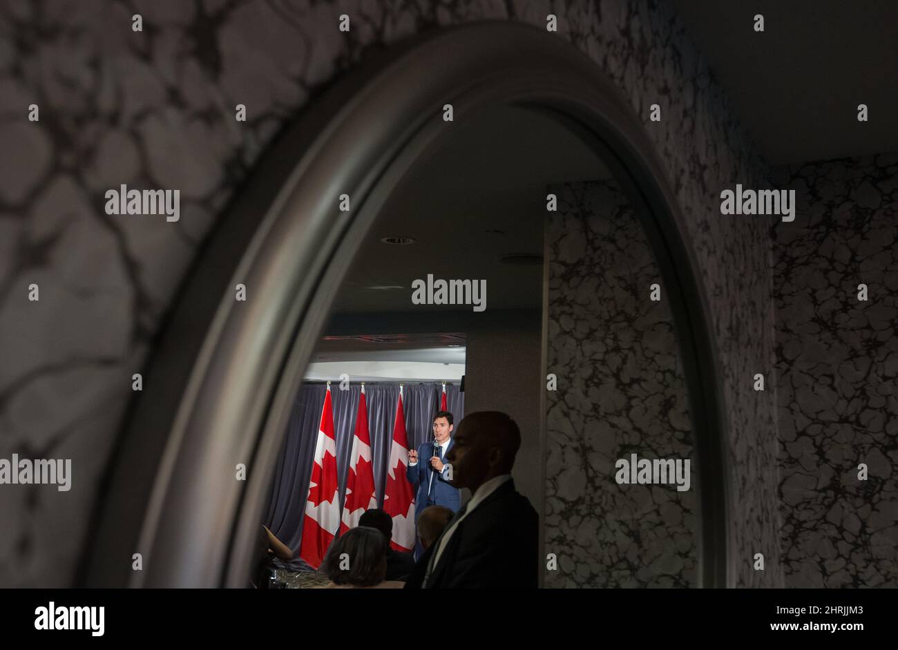 Reflected in a mirror, Prime Minister Justin Trudeau speaks as a member ...