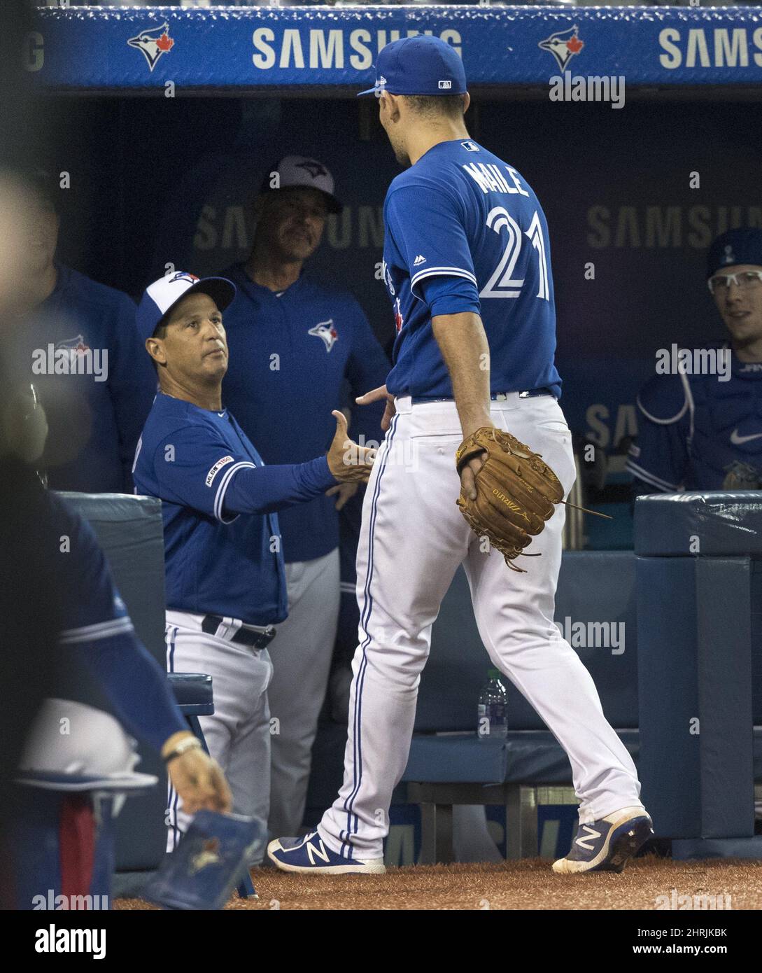 Toronto Blue Jays catcher Luke Maile gets a hand shake from manager ...