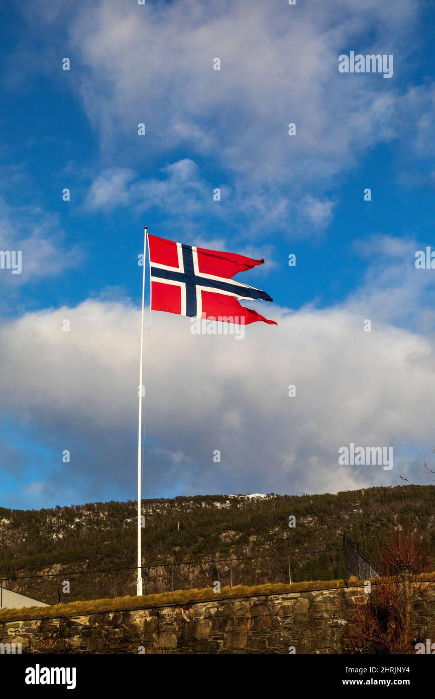Norwegian national flag in the wind, at Bergenhus fort in the port of ...