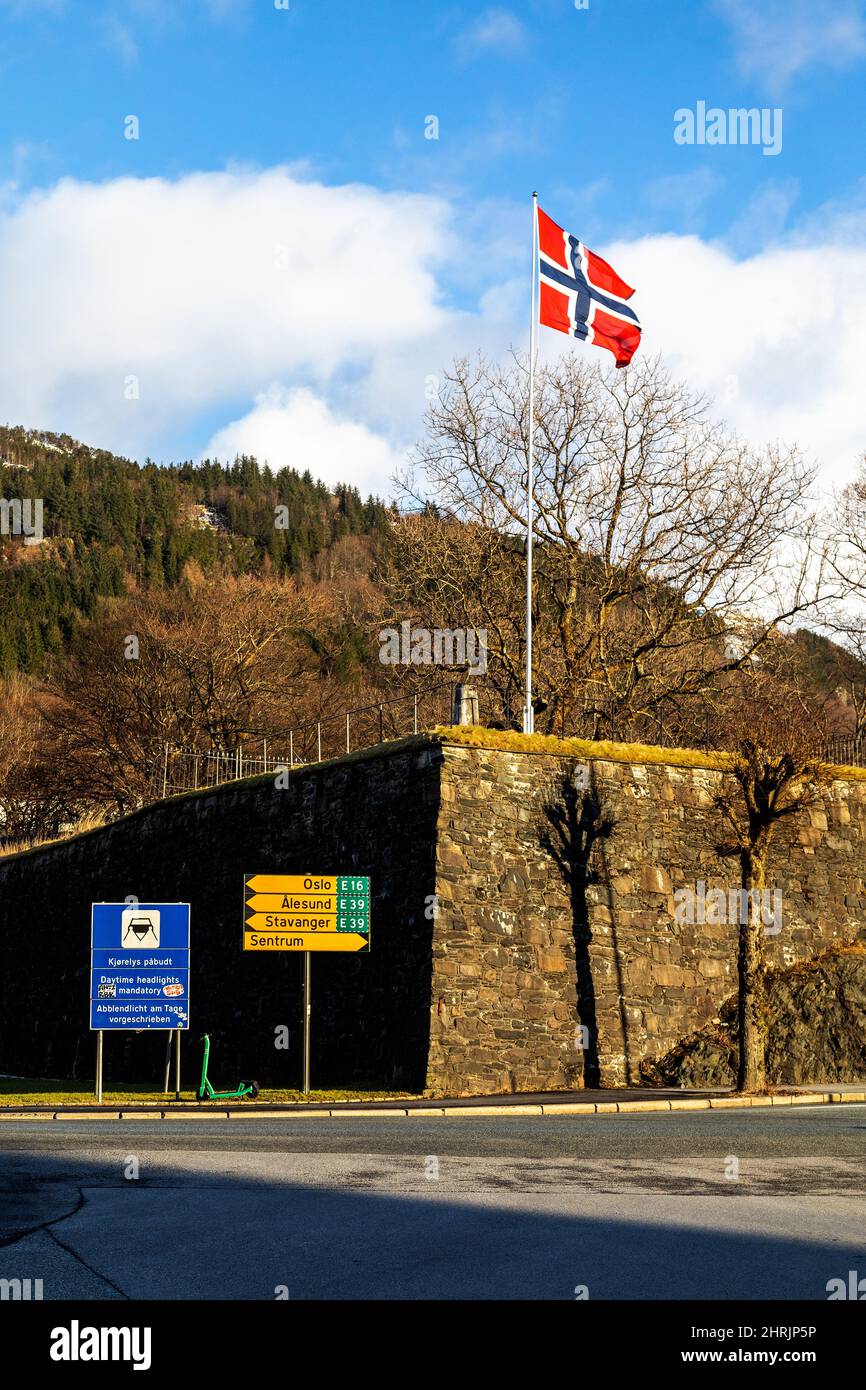 Norwegian national flag in the wind, at Bergenhus fort in the port of ...