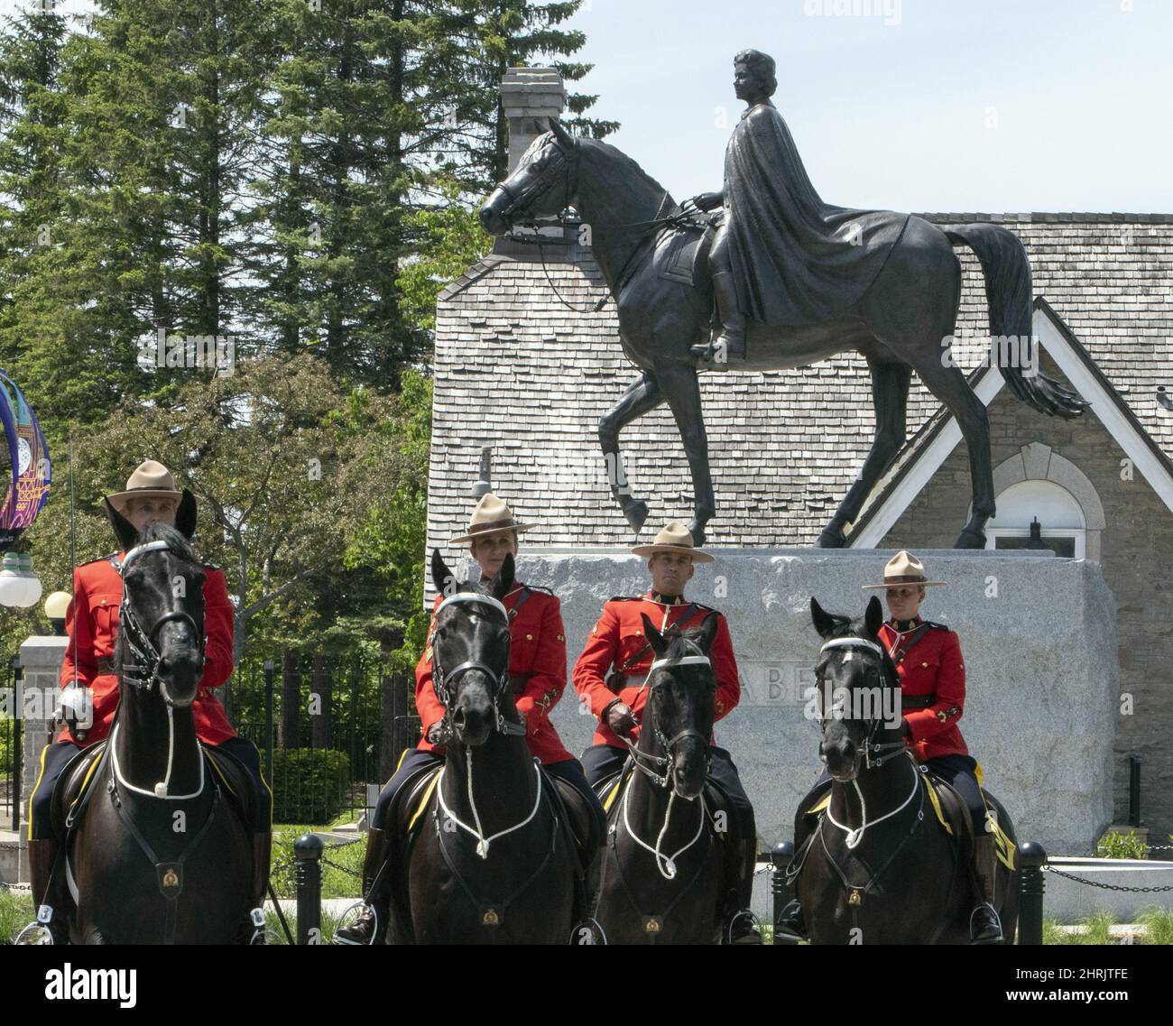 The Queen Elizabeth II Equestrian Monument is shown with members of the ...