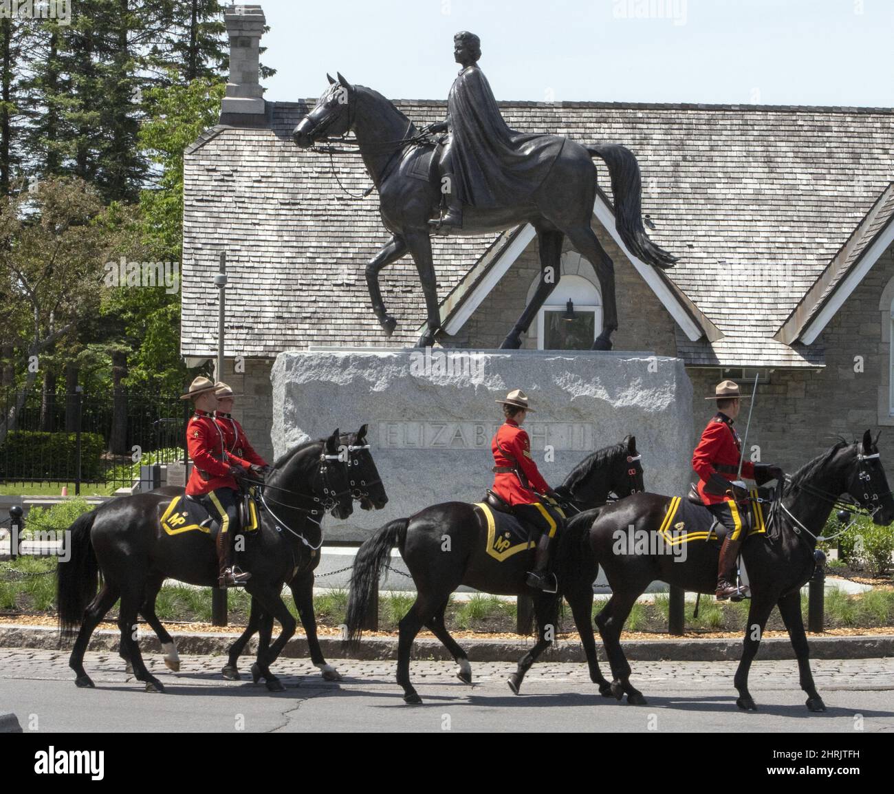 Members of the RCMP Musical Ride, ride past the Queen Elizabeth II ...