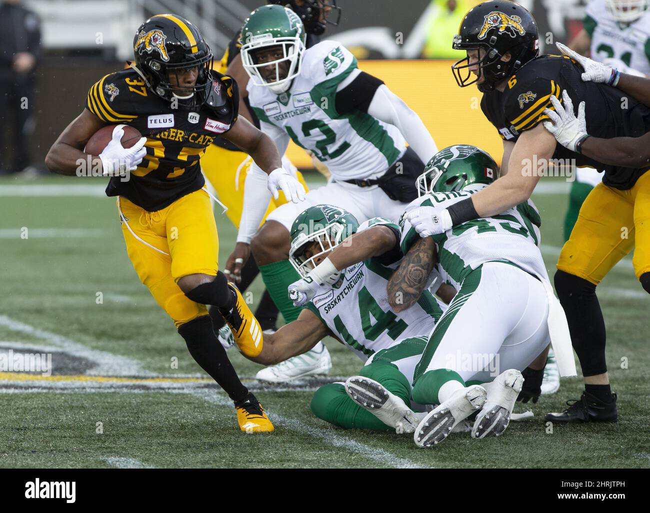 Hamilton Tiger-Cats' Frankie Williams eludes the clutches of defending ...