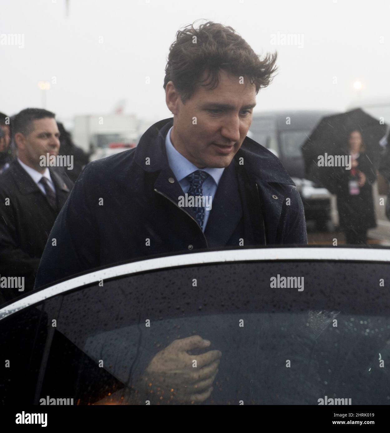Canadian Prime Minister Justin Trudeau gets into a car as he arrives in ...