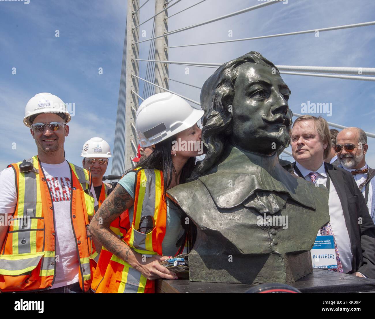 Construction worker Catherine Desautels kisses a bust of Samuel de ...