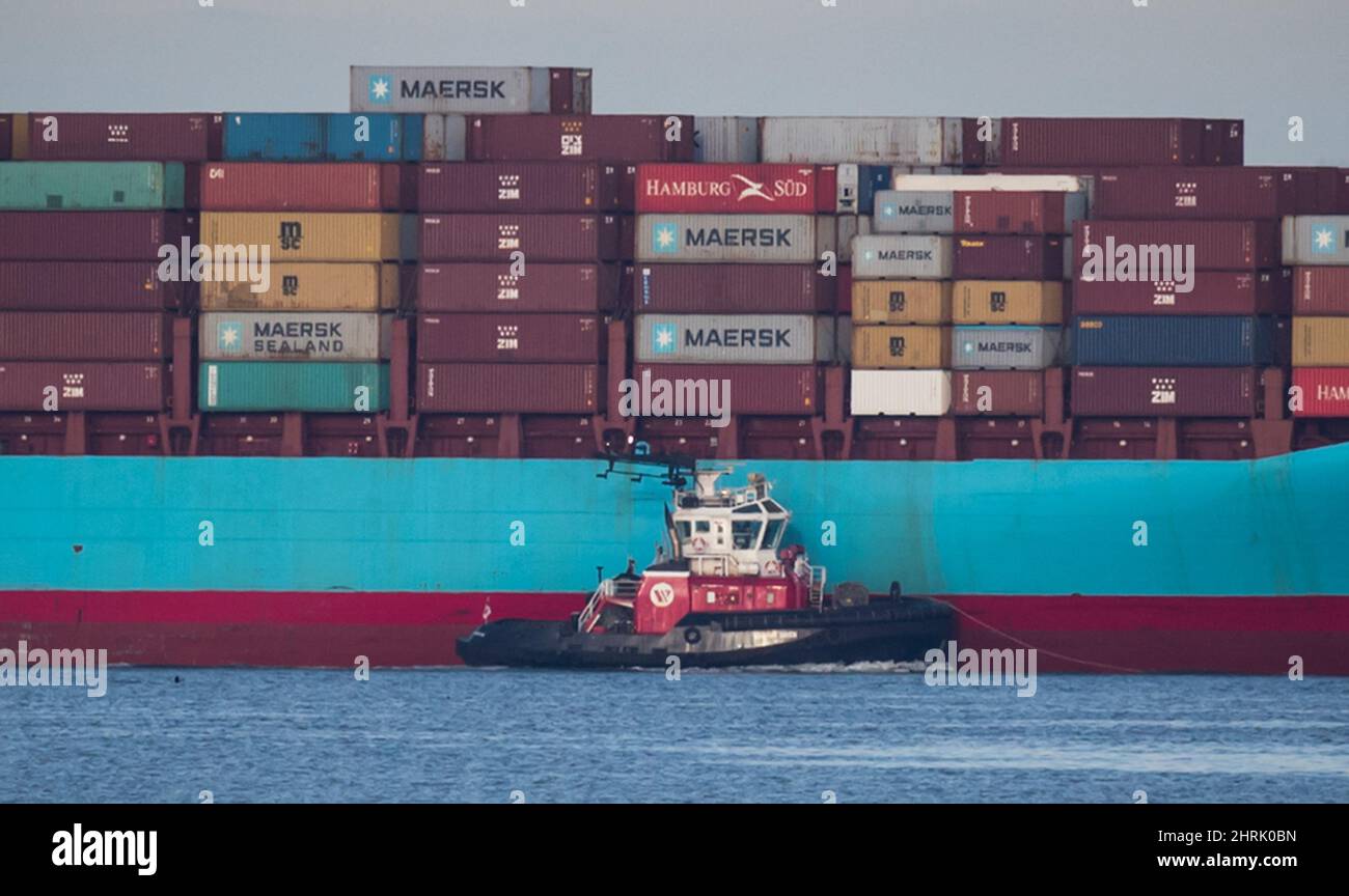 A tugboat guides the Anna Maersk container ship, carrying 69 containers ...