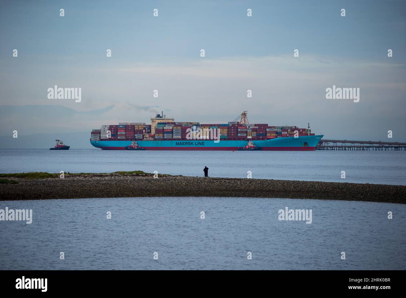 Tugboats guide the Anna Maersk container ship, carrying 69 containers ...