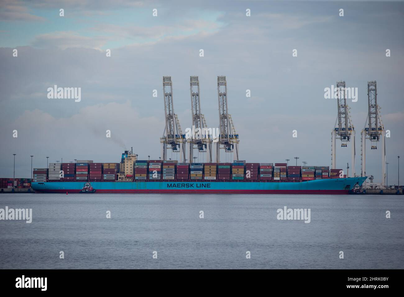 Tugboats guide the Anna Maersk container ship, carrying 69 containers ...