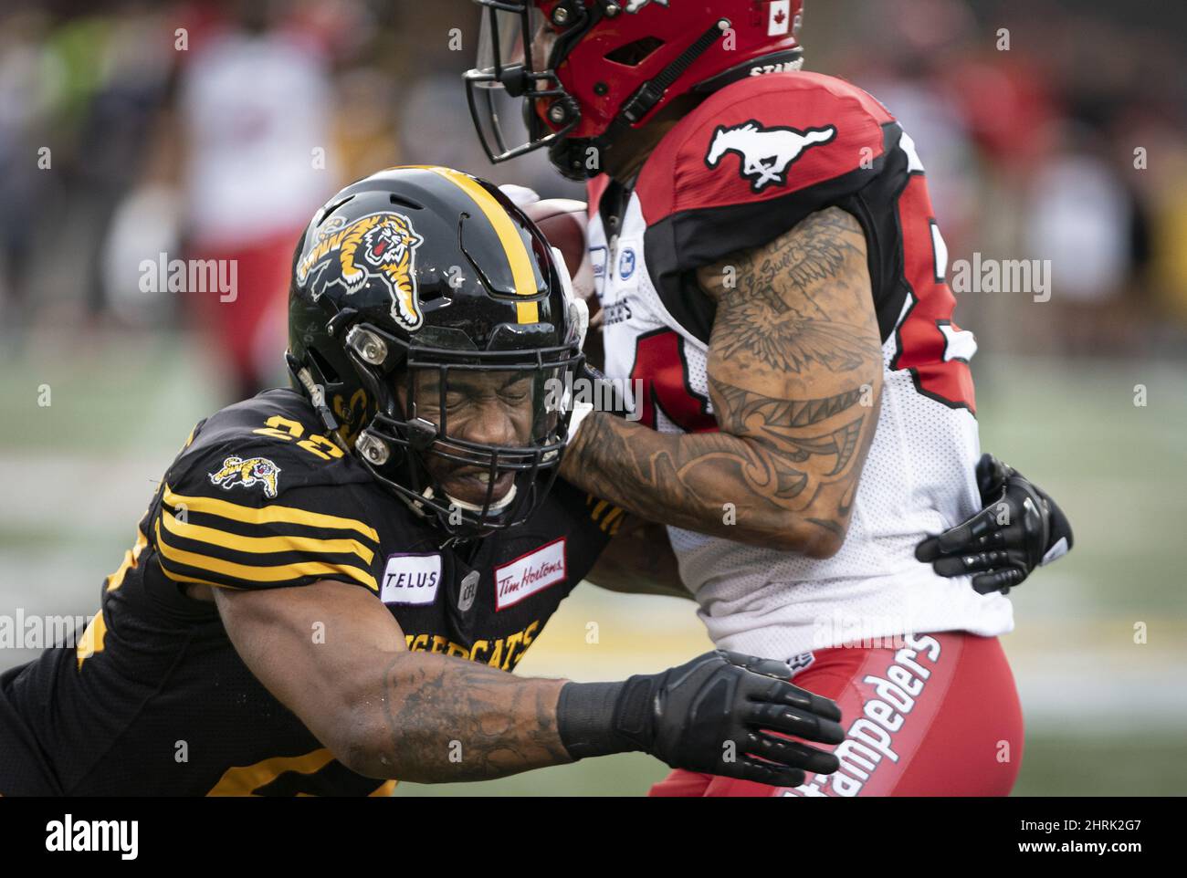 Hamilton Tiger Cats linebacker Justin Tuggle (22) tackles Calgary ...