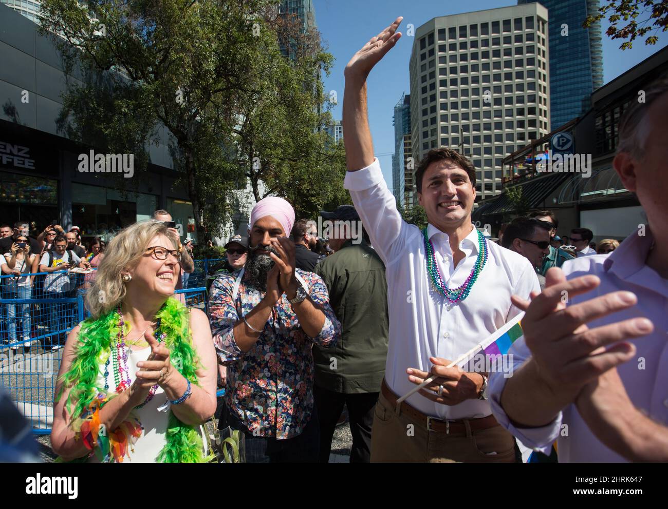 Prime Minister Justin Trudeau, right, waves to the crowd while waiting ...