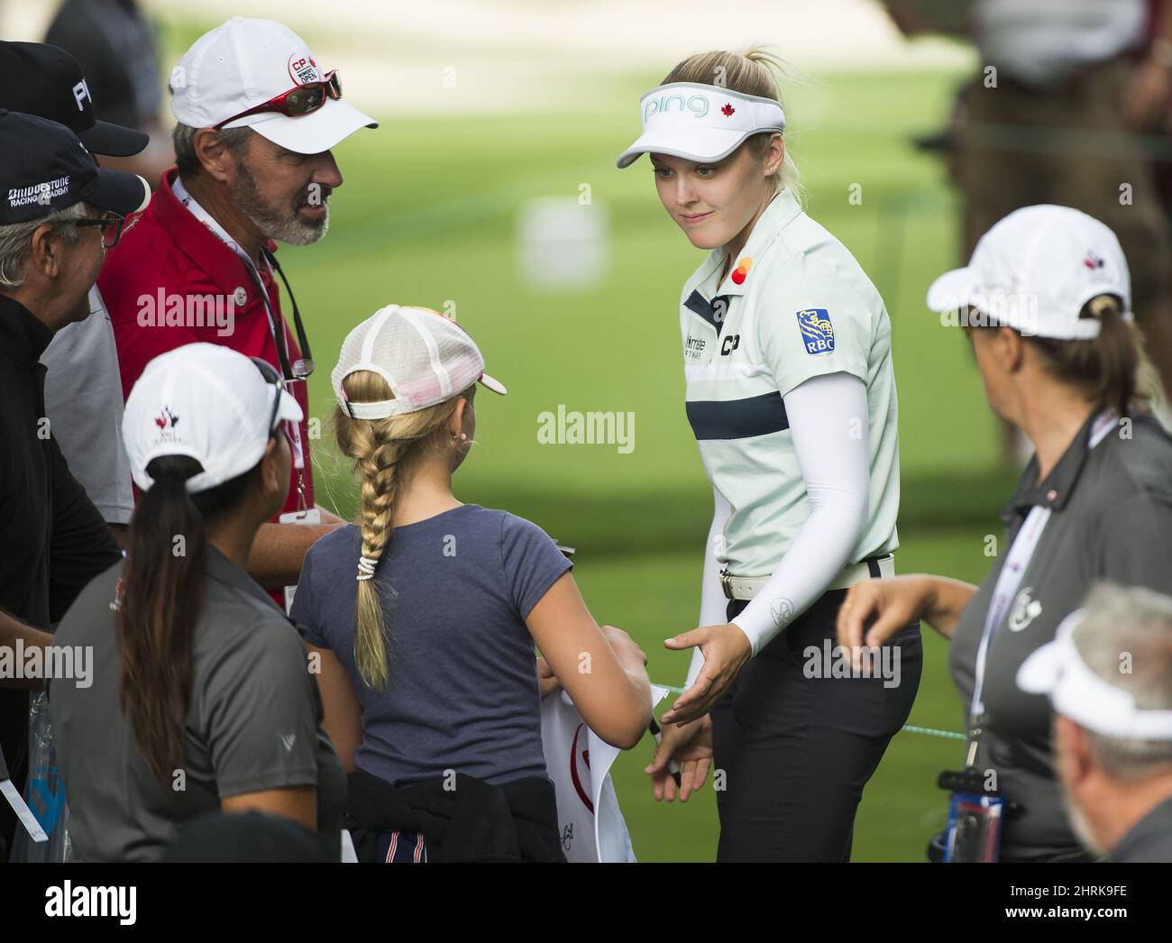 Canadian Brooke Henderson, centre, signs autographs for fans on the ...