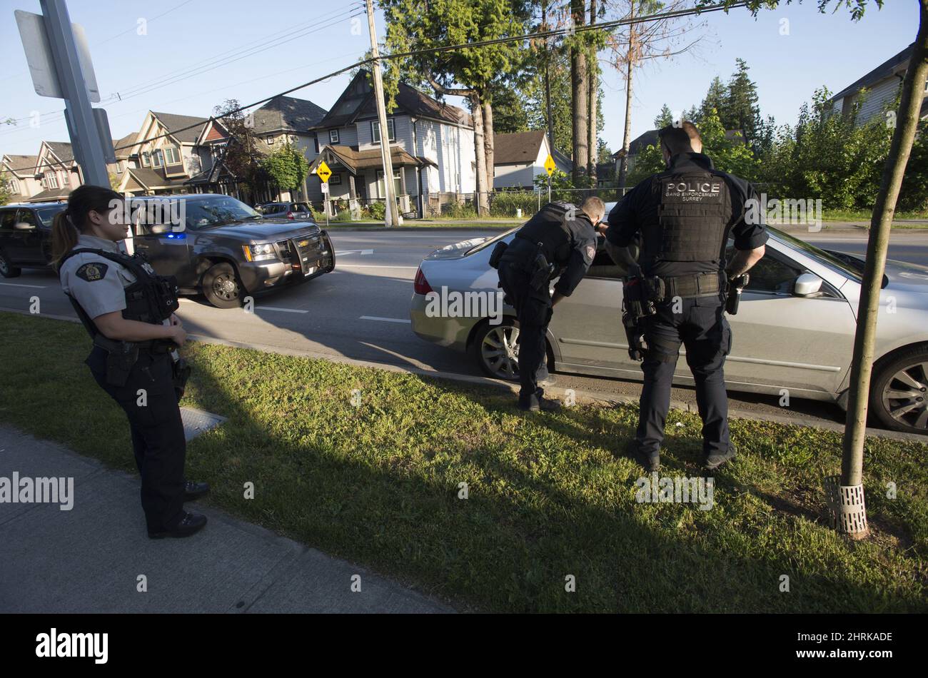Members of the RCMP Gang Enforcement Team is silhouetted as he speaks ...