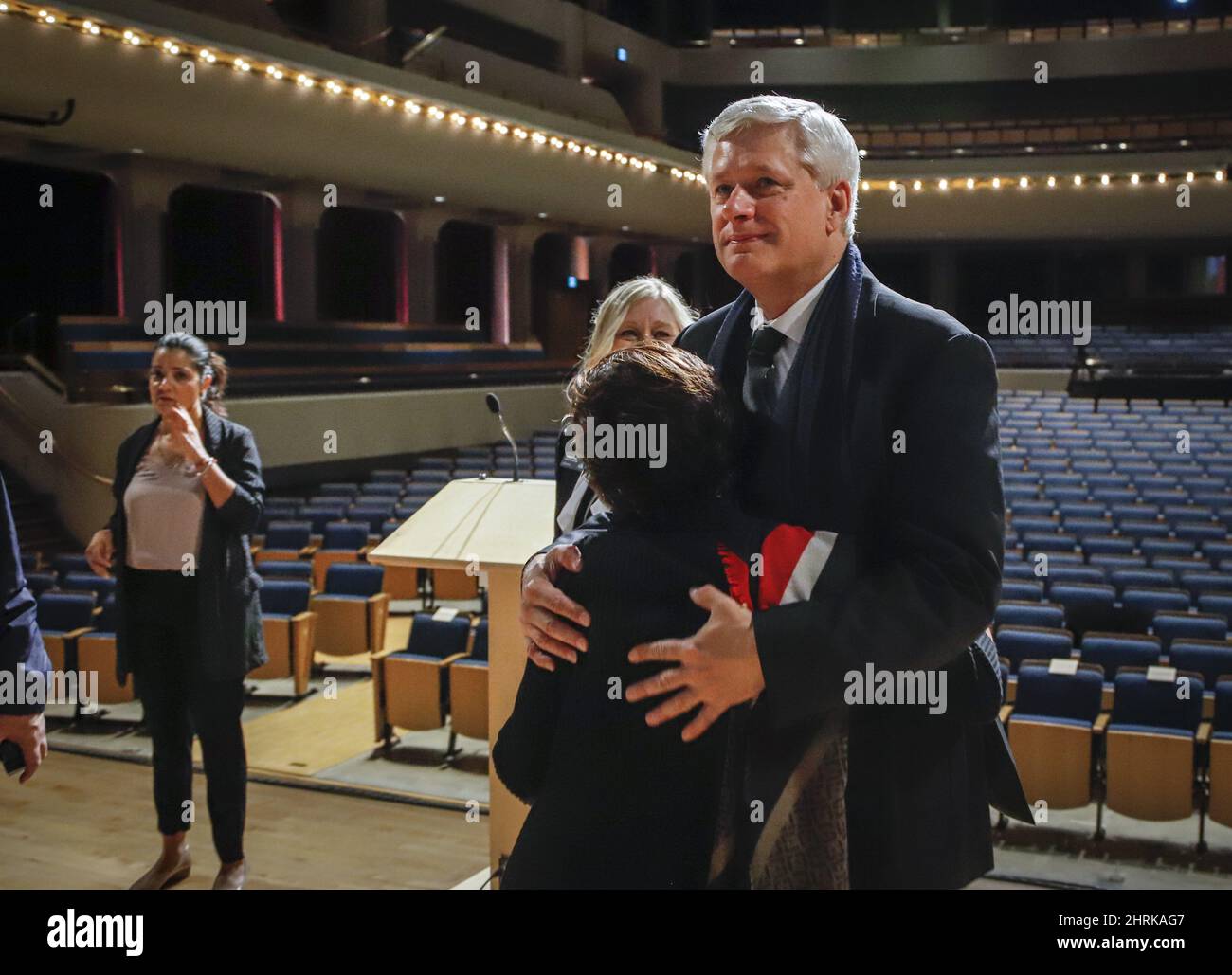 Former Prime Minister Stephen Harper, right, comforts Neena Obhrai ...