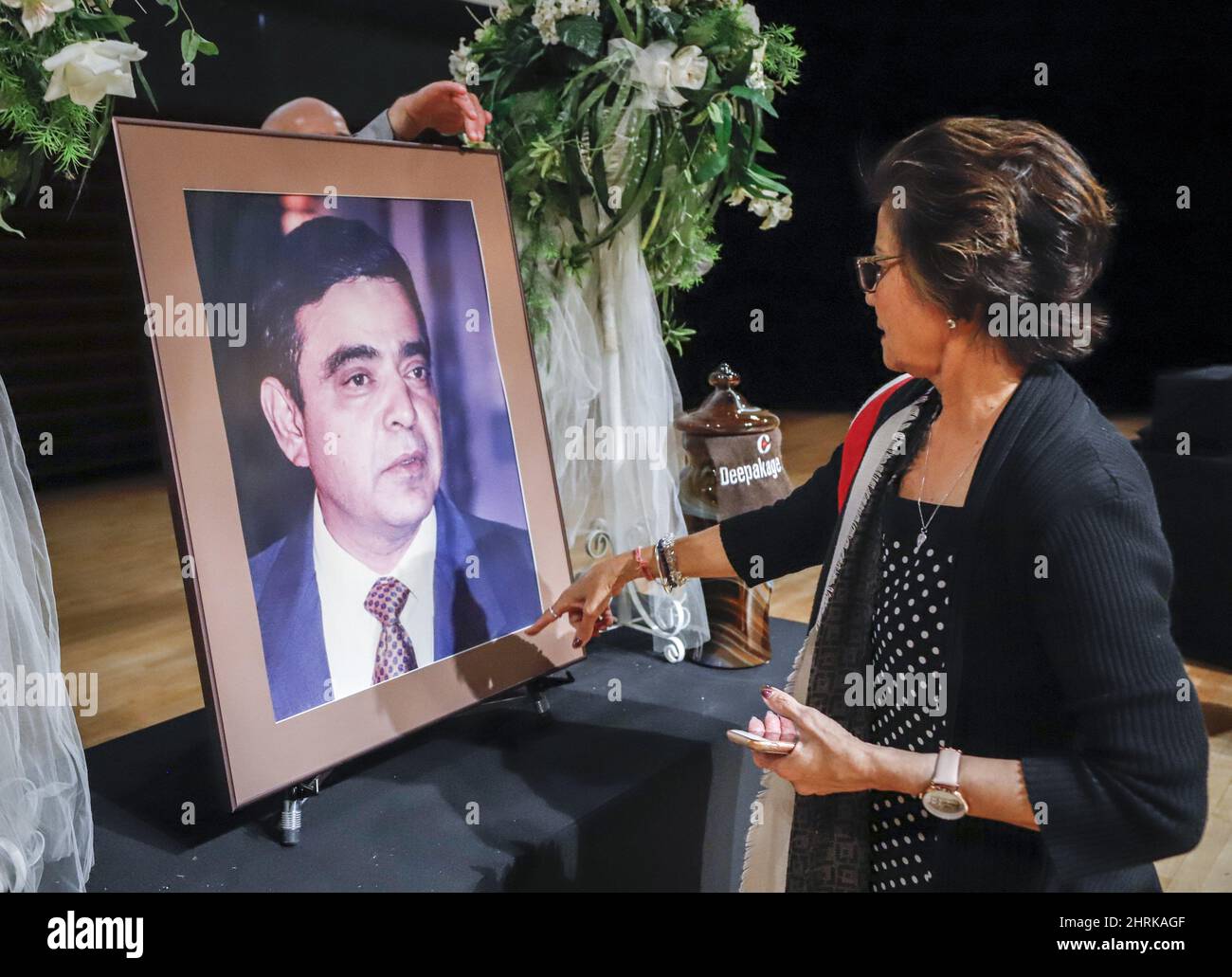 Neena Obhrai looks at a photo of her late husband Deepak Obhari at a ...