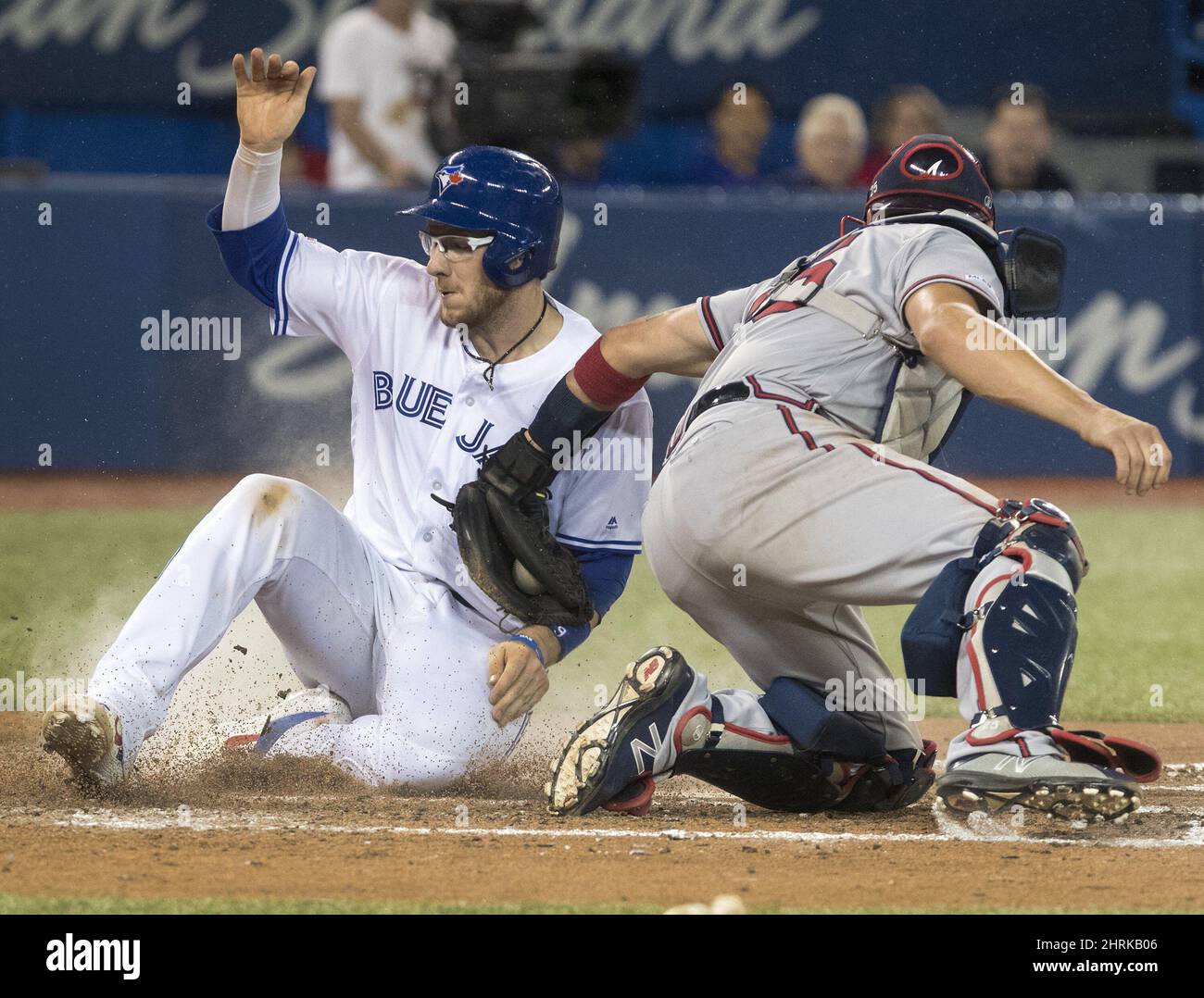 Toronto Blue Jays' Danny Jansen scores under the tag attempt by Atlanta ...