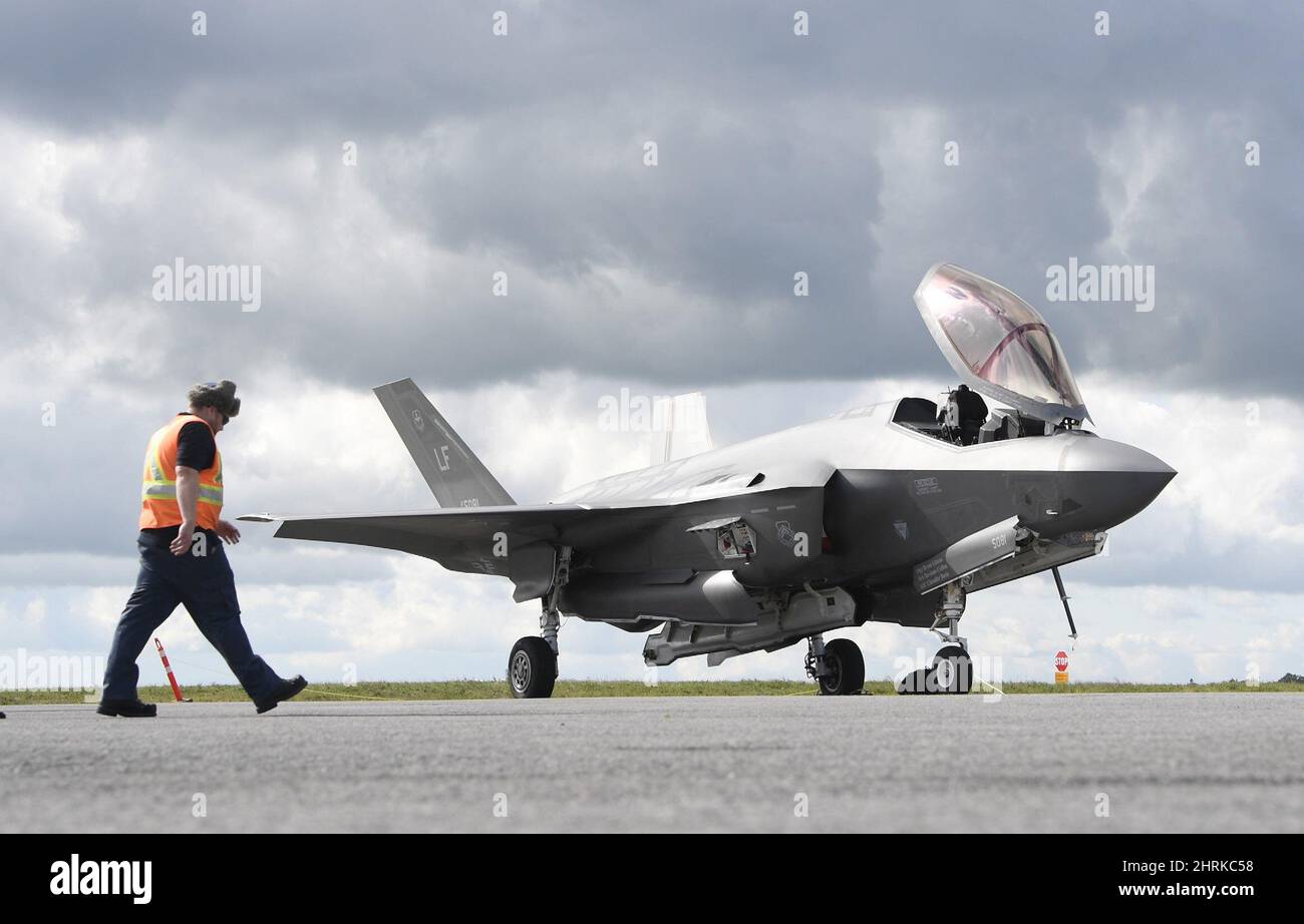 An Ottawa airport ground crew member walks past a parked F-35A ...