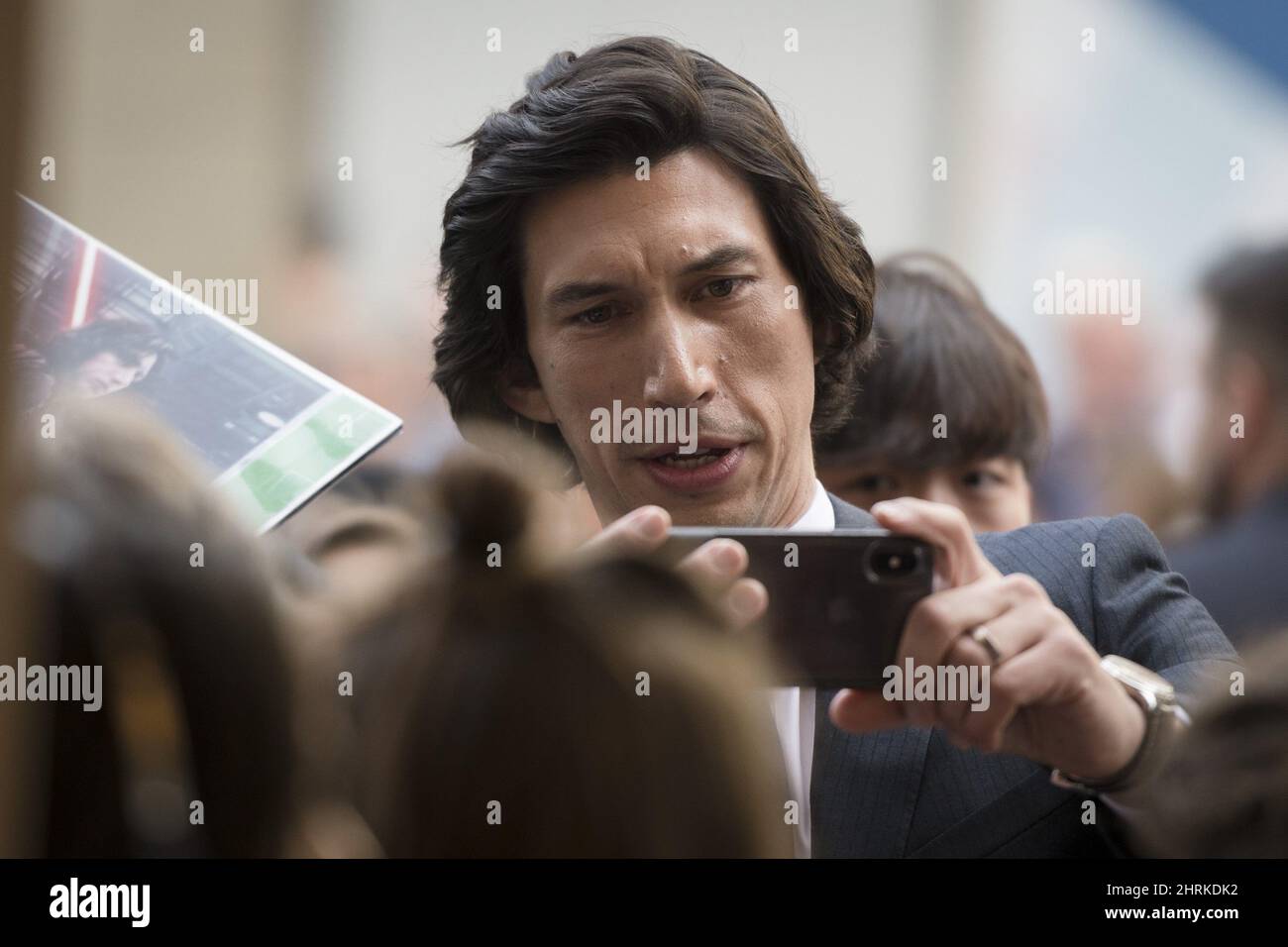 Actor Adam Driver takes a photograph with his fans before stepping on ...
