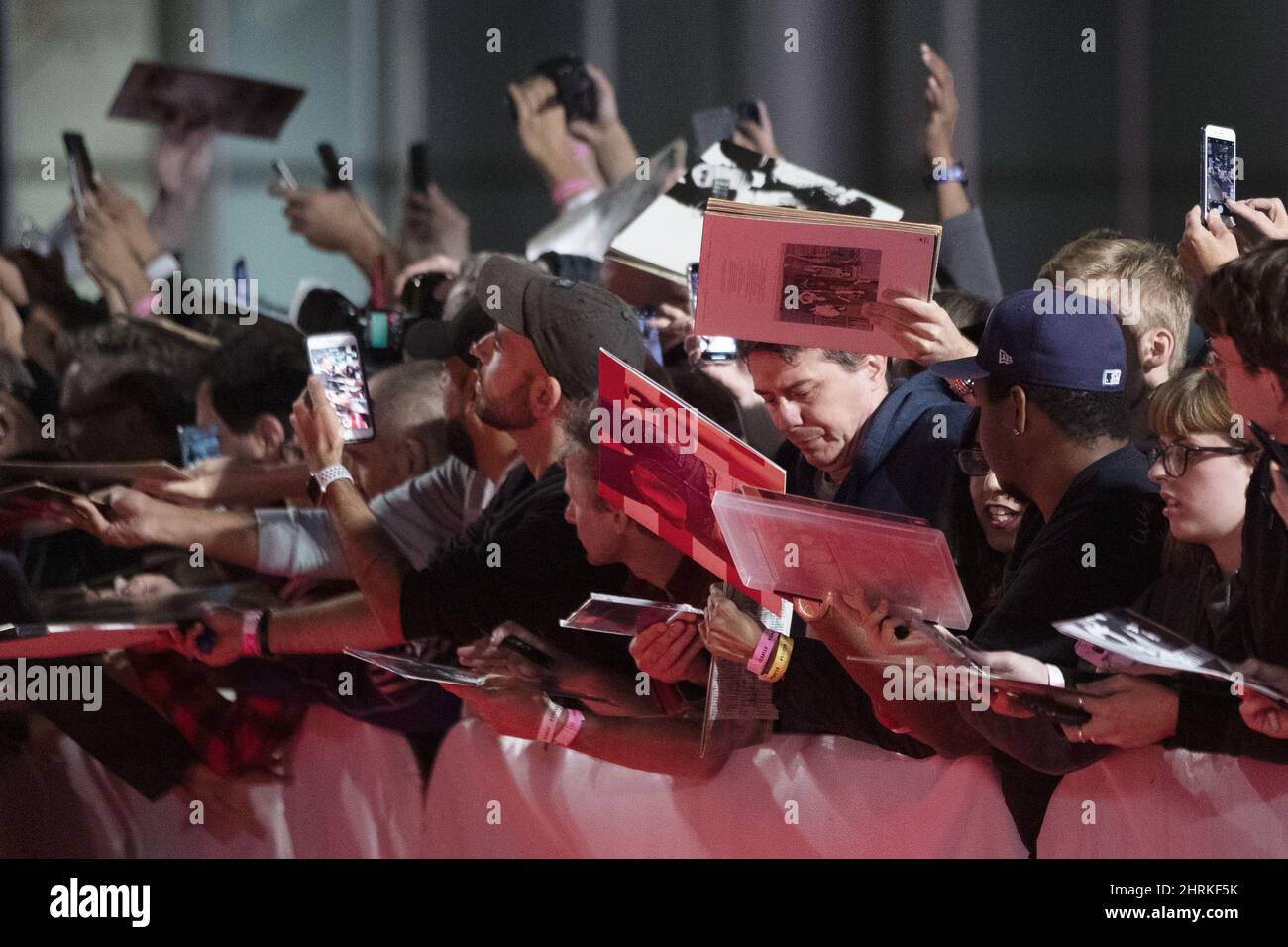 Fans hold up Bruce Springsteen records as the singer arrives on the red ...