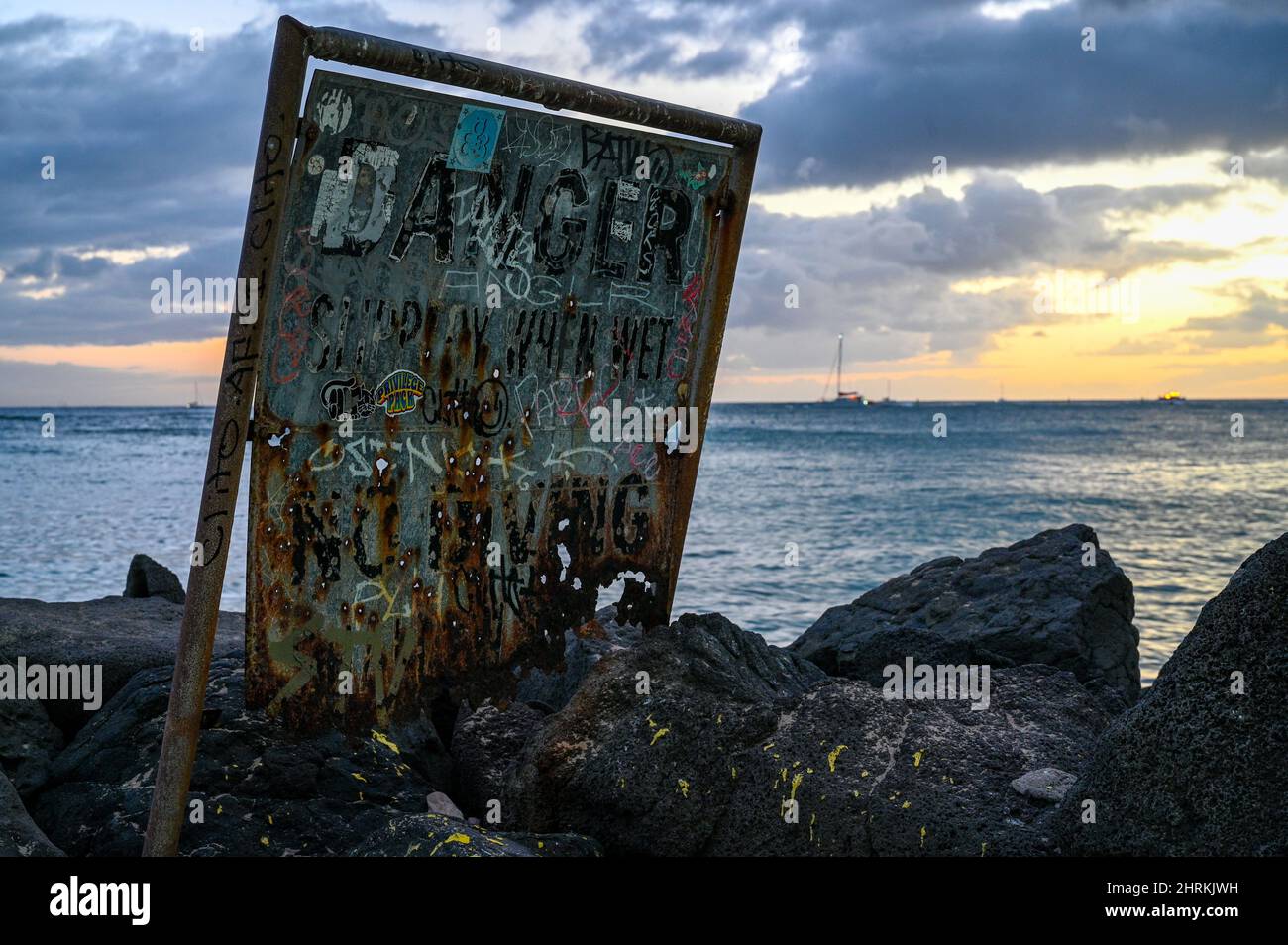 View of an old rusty metal stand on the beach at the beautiful sunset ...