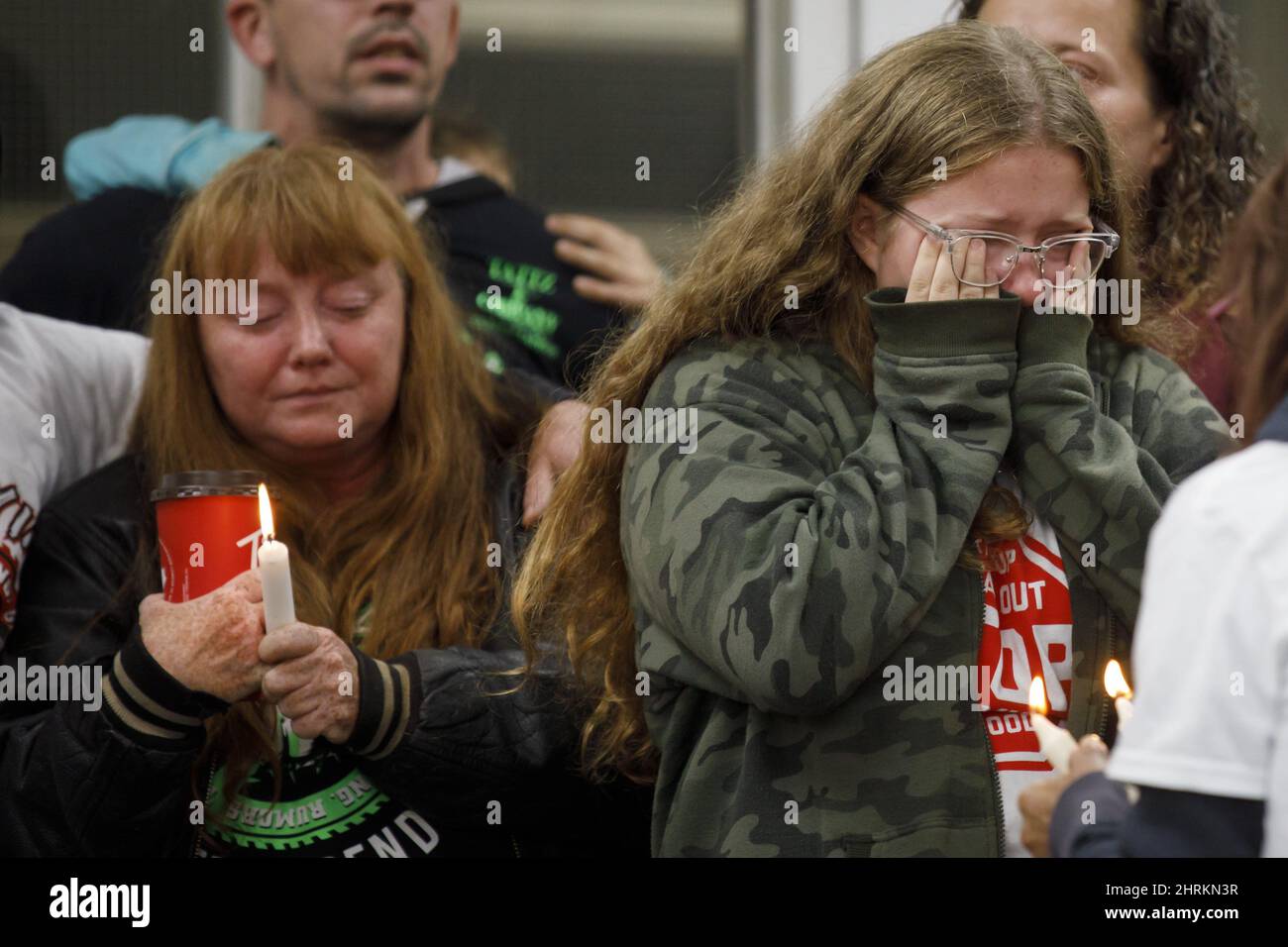 Shari-Ann Bracci-Selvey, left, fights back tears at a vigil for her 14 ...