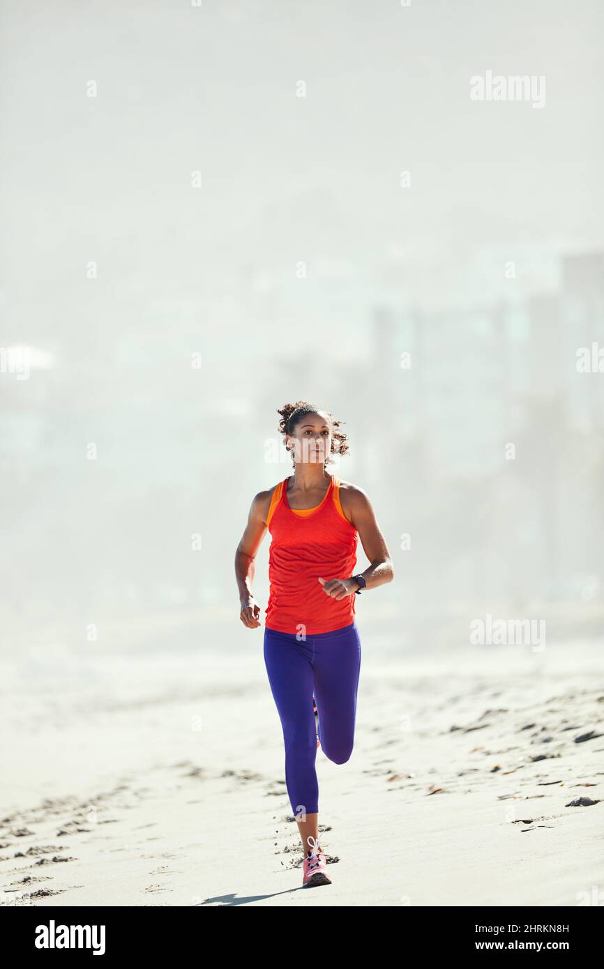 Theres something magical about running. Shot of a sporty young woman ...