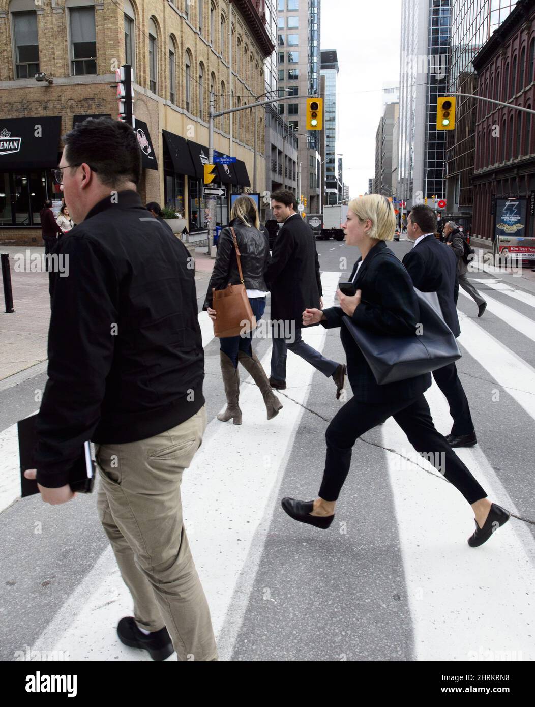 Prime Minister Justin Trudeau and staff make their way from a press ...