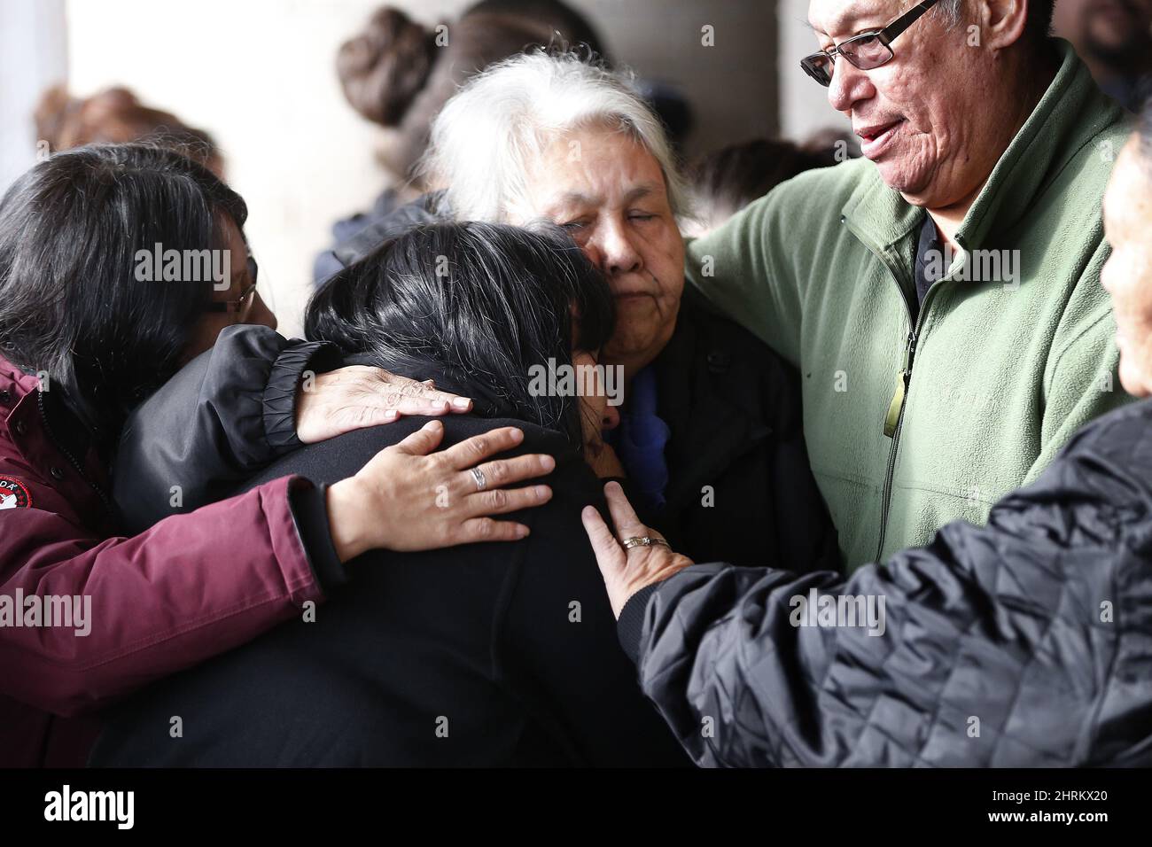 The mother, centre, of Hunter Haze Straight-Smith is comforted at a ...