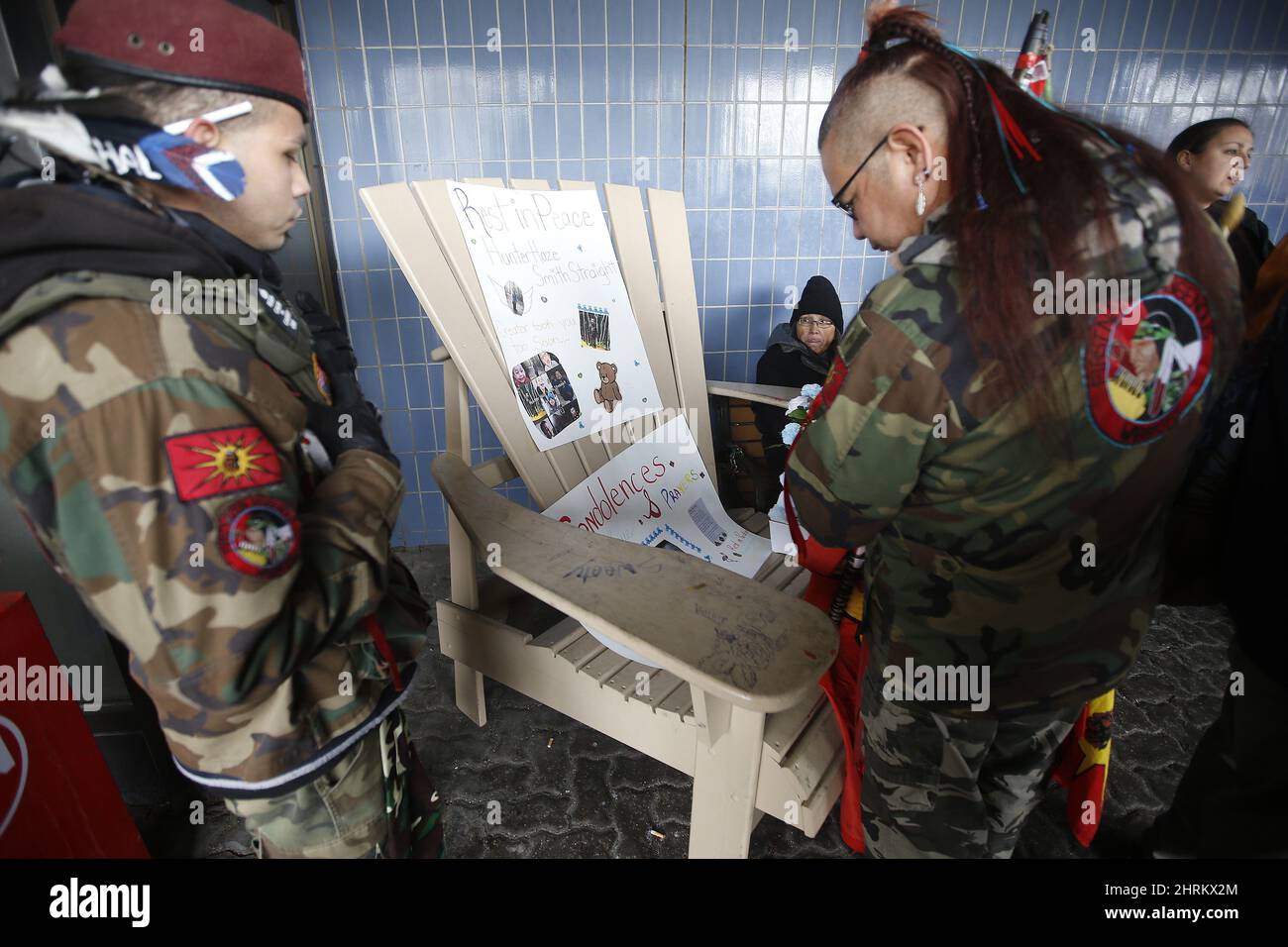 Members of the First Nation Indigenous Warriors look at posters of ...